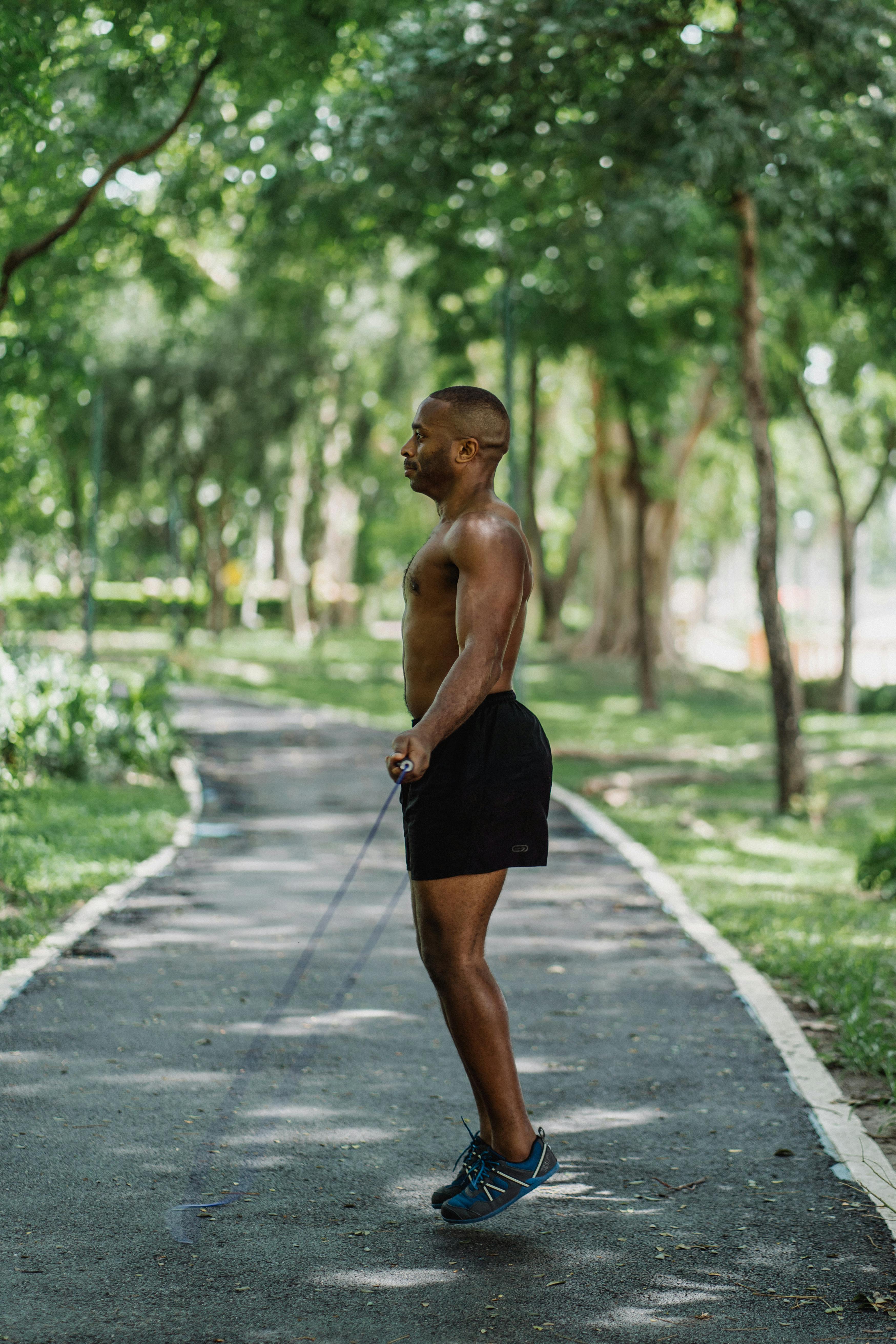 Man Wearing Blue Shirt Using Gym Equipments · Free Stock Photo
