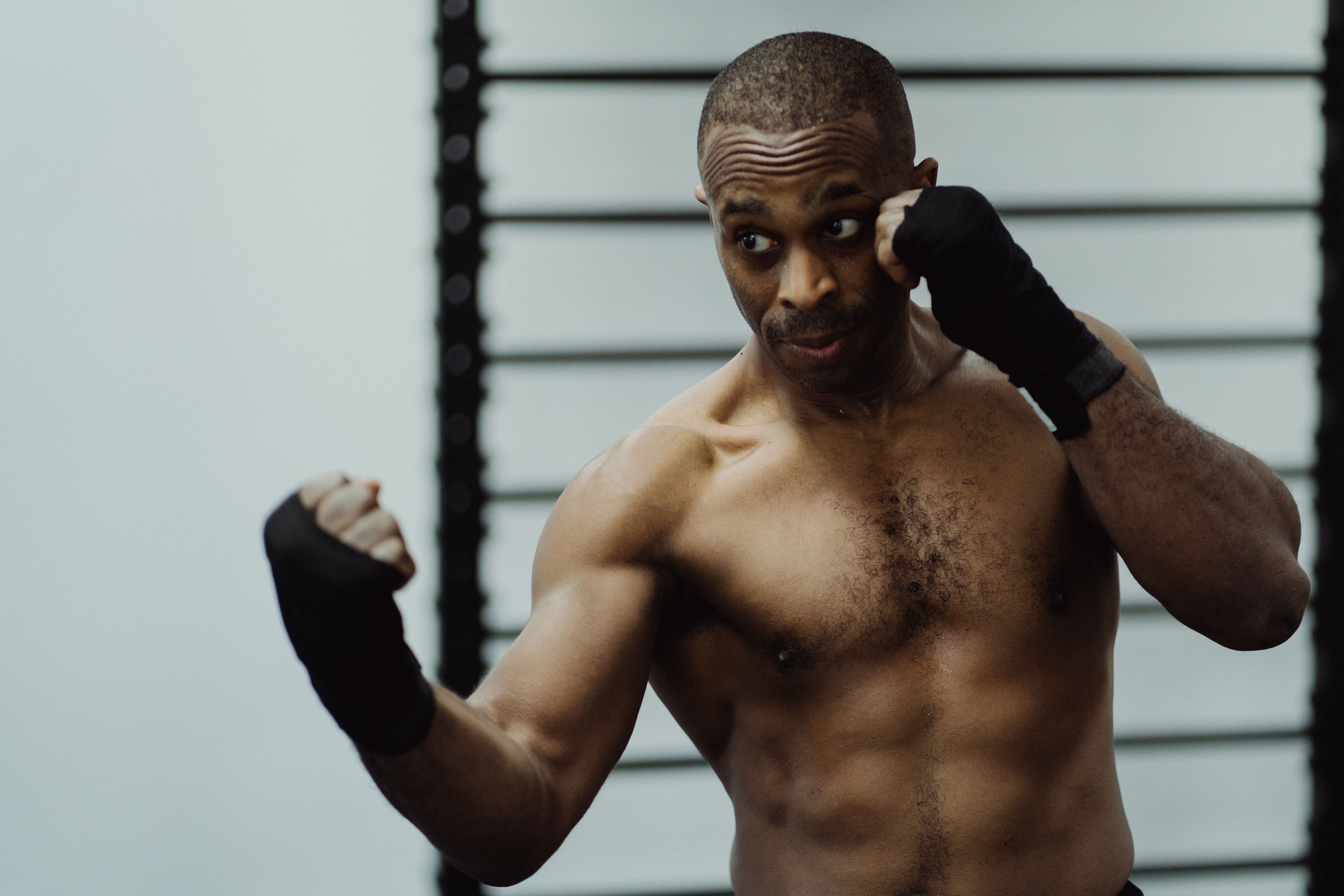 A Boxer Wearing Black Bandages on His Hands · Free Stock Photo