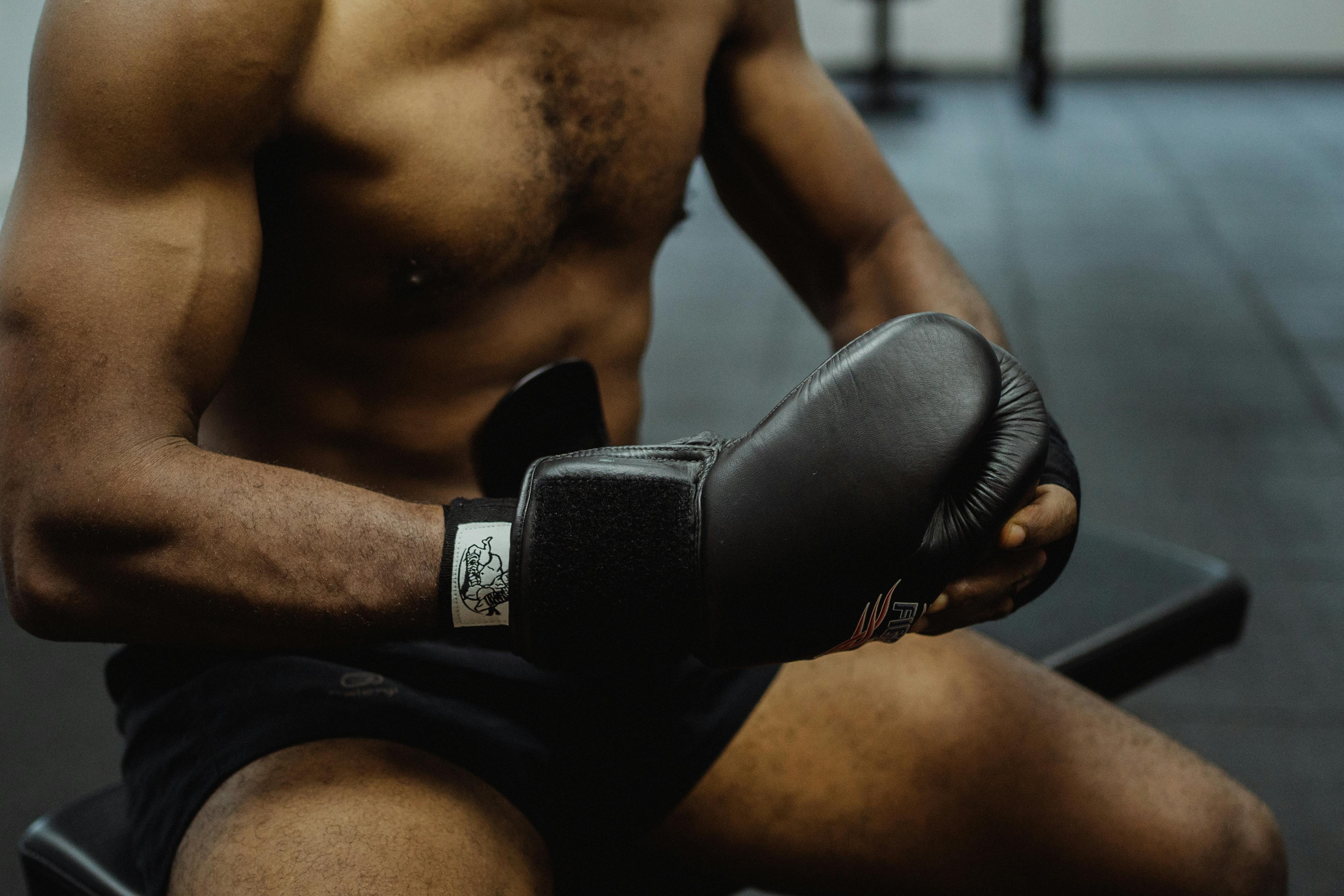 A Man Wearing Black Boxing Gloves · Free Stock Photo