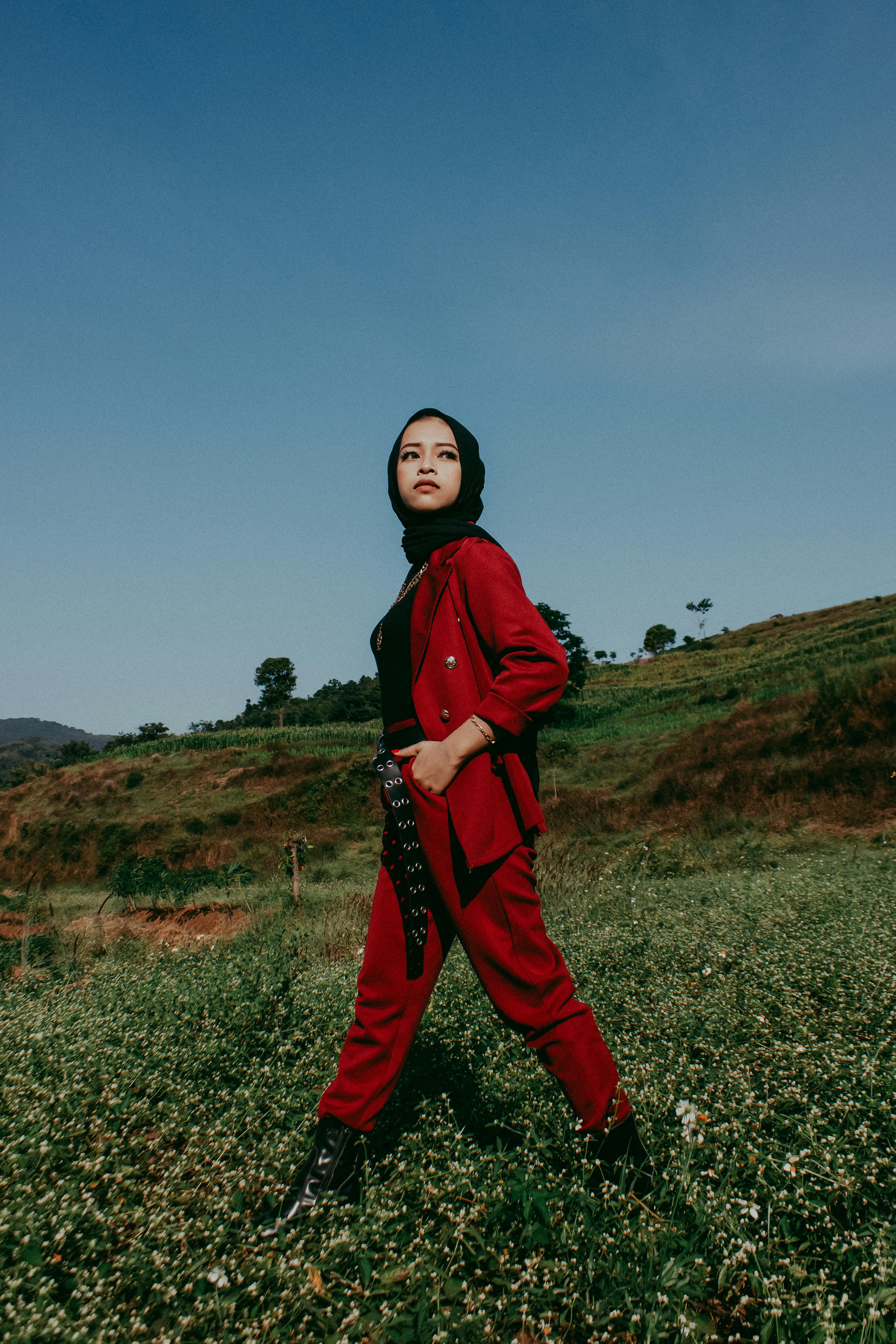 Woman in Red Outfit Standing on Green Field · Free Stock Photo