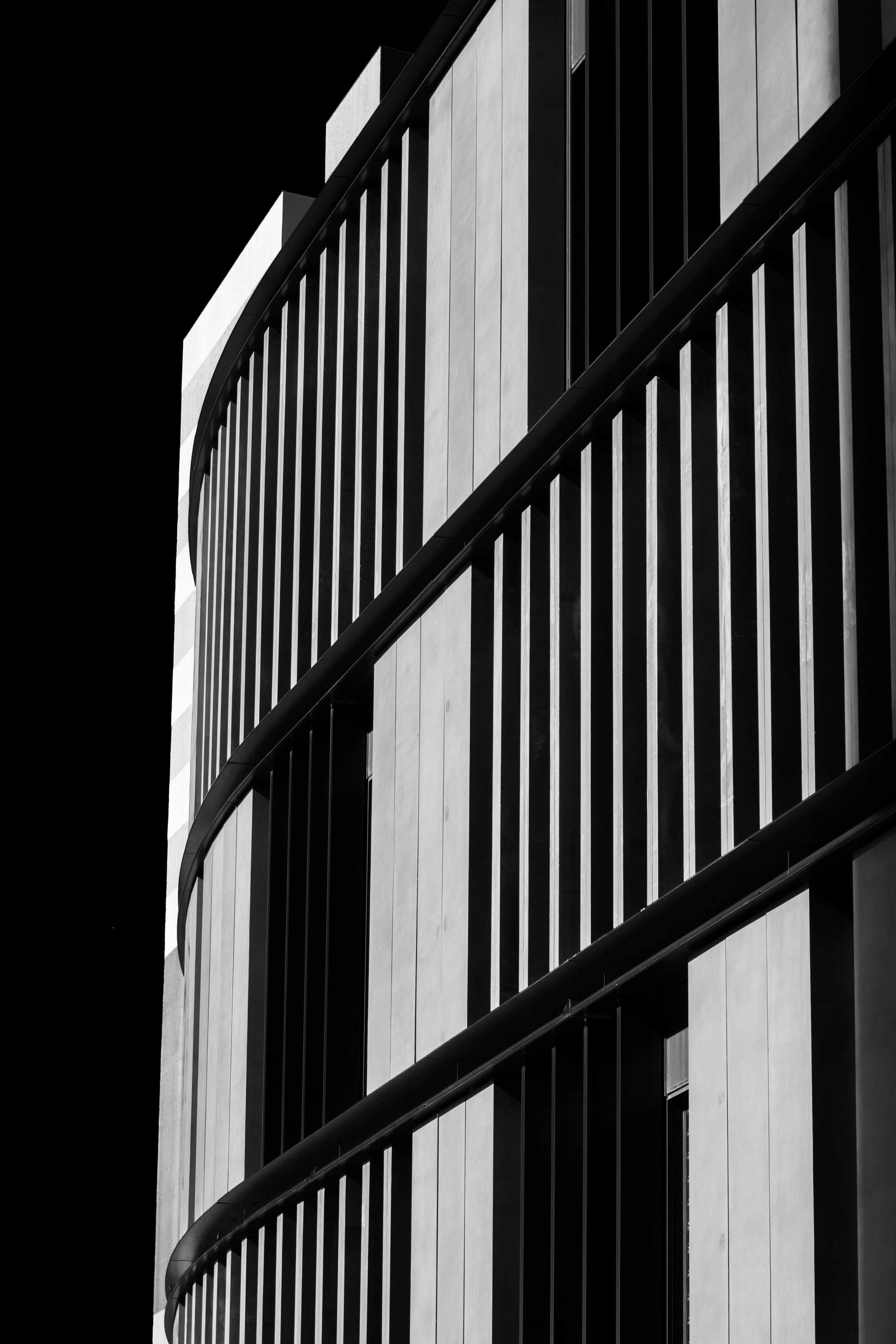A Grayscale of a Modernly Designed Building · Free Stock Photo
