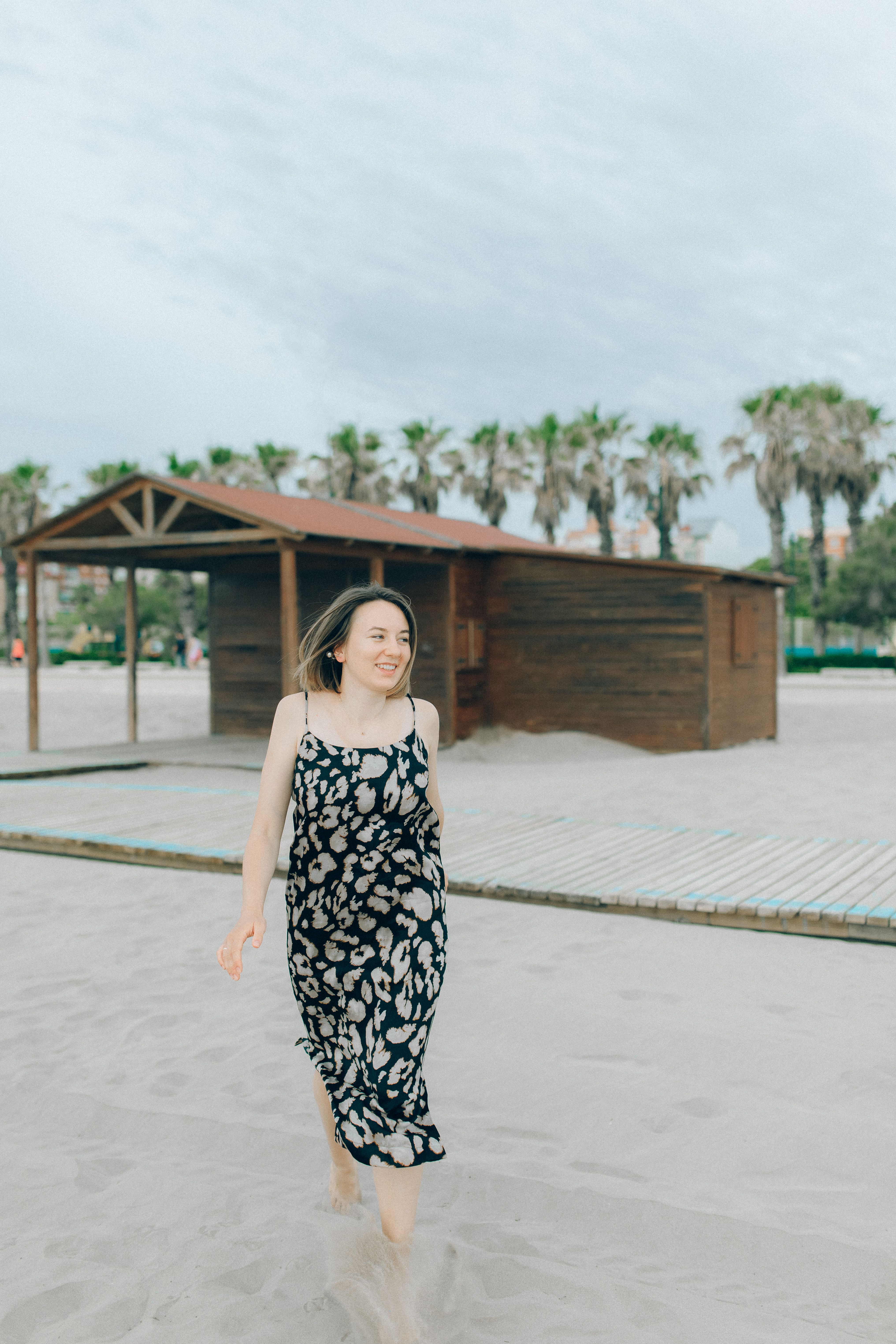 A Woman Wearing a Spaghetti Strap Dress Walking on the Sand · Free ...