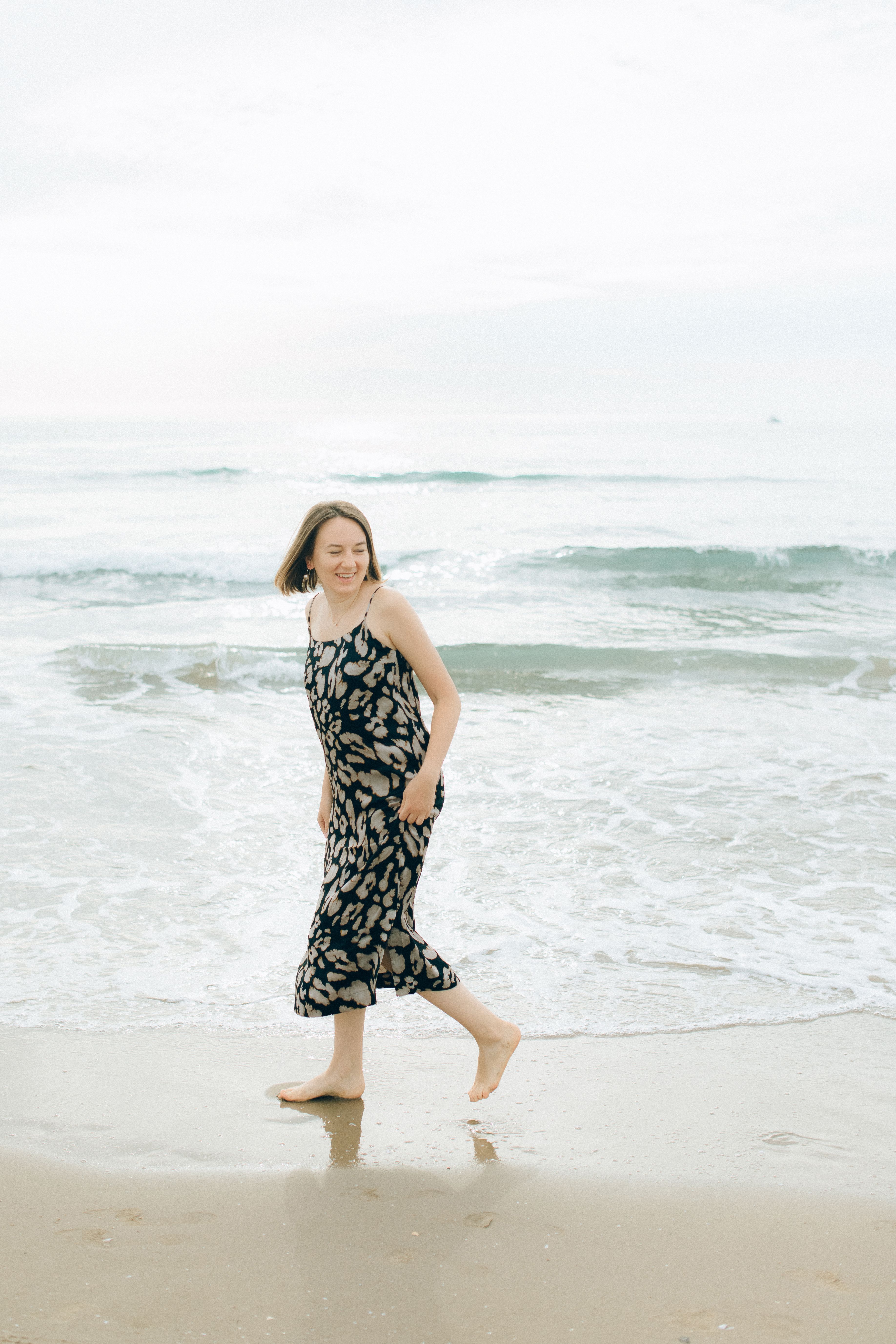 A Woman Wearing a Spaghetti Strap Dress on a Shore · Free Stock Photo