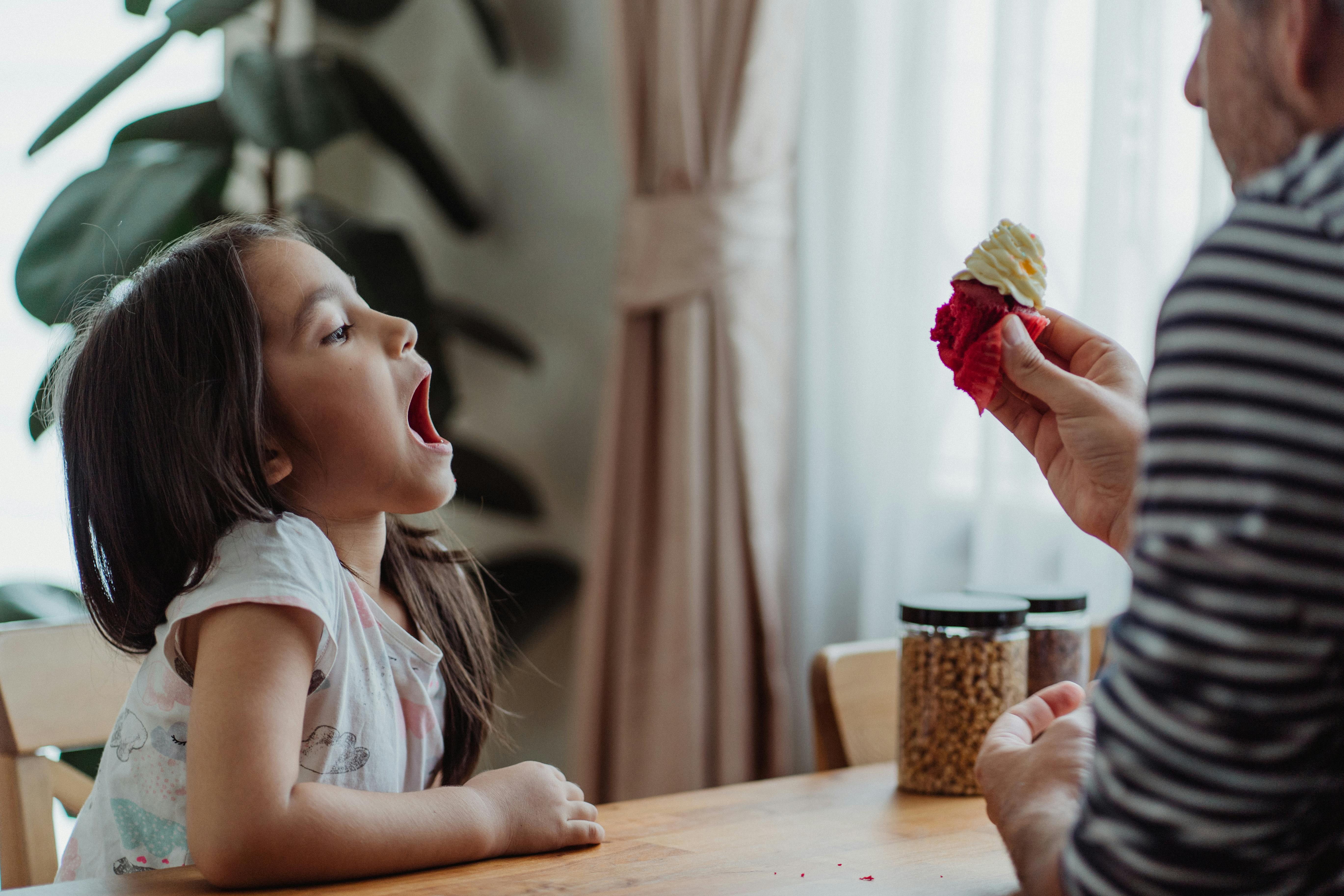 Father Giving his Daughter a Treat · Free Stock Photo