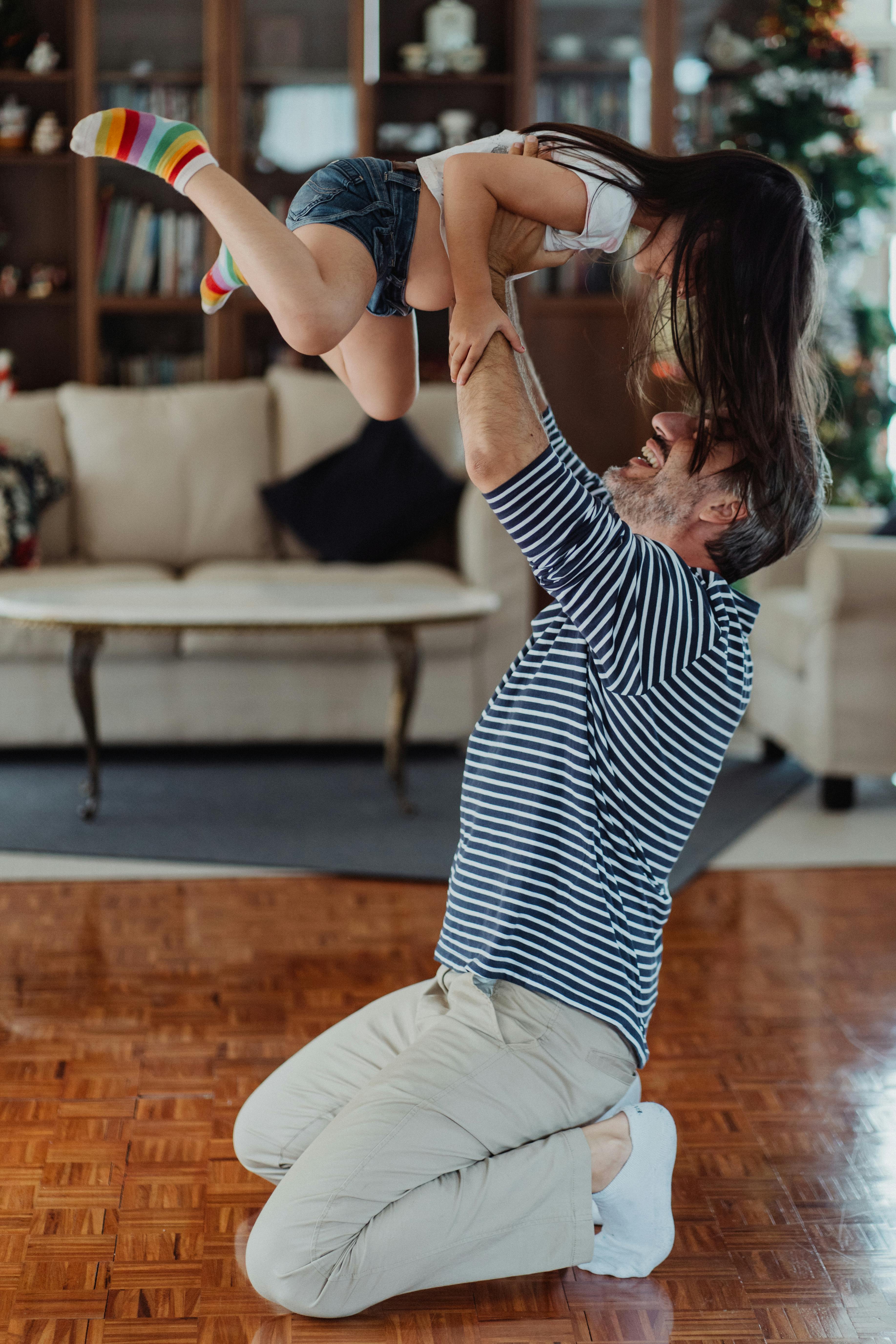 Photo of a Father Lifting His Daughter · Free Stock Photo
