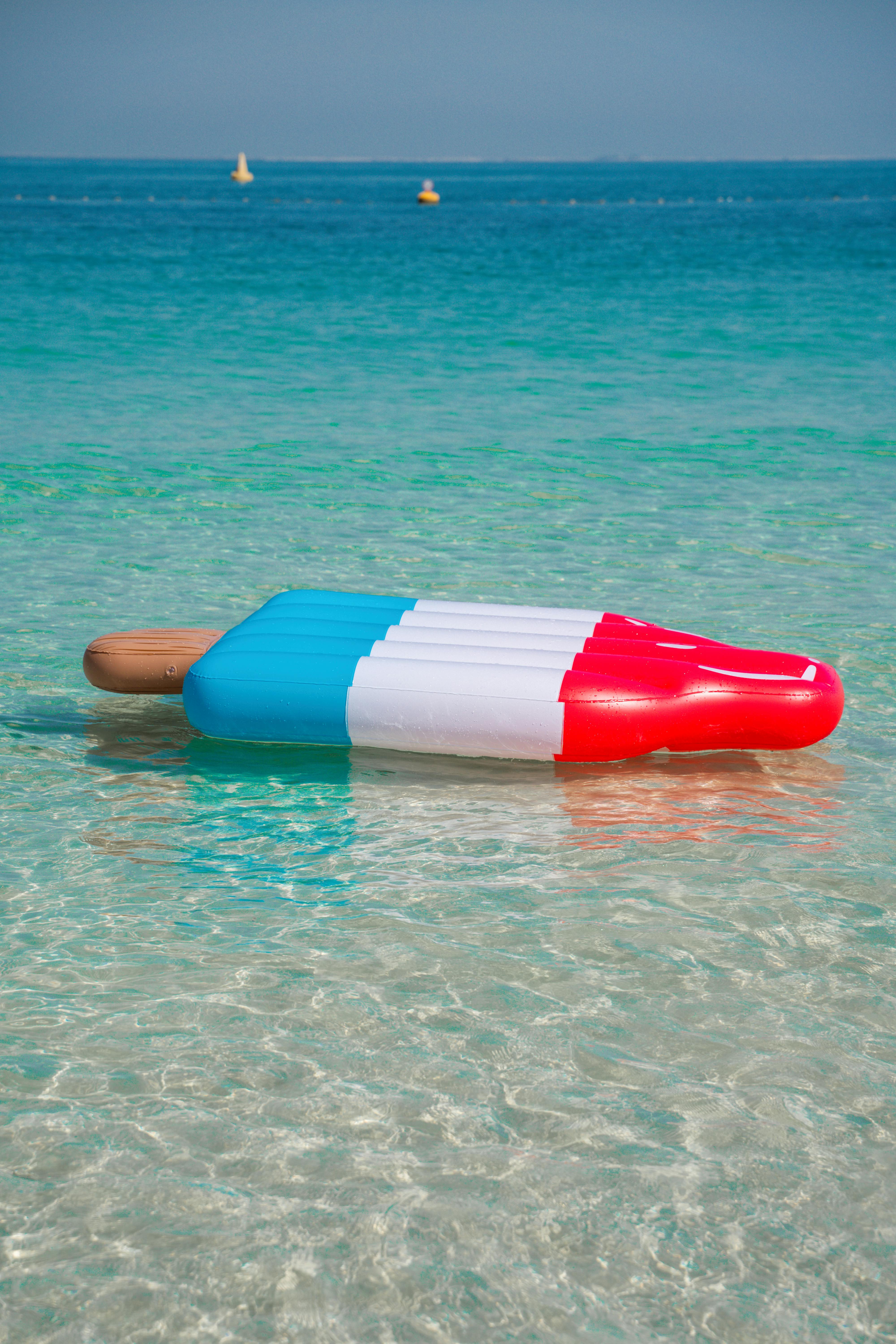 Red and White Stripe Floater on Water · Free Stock Photo