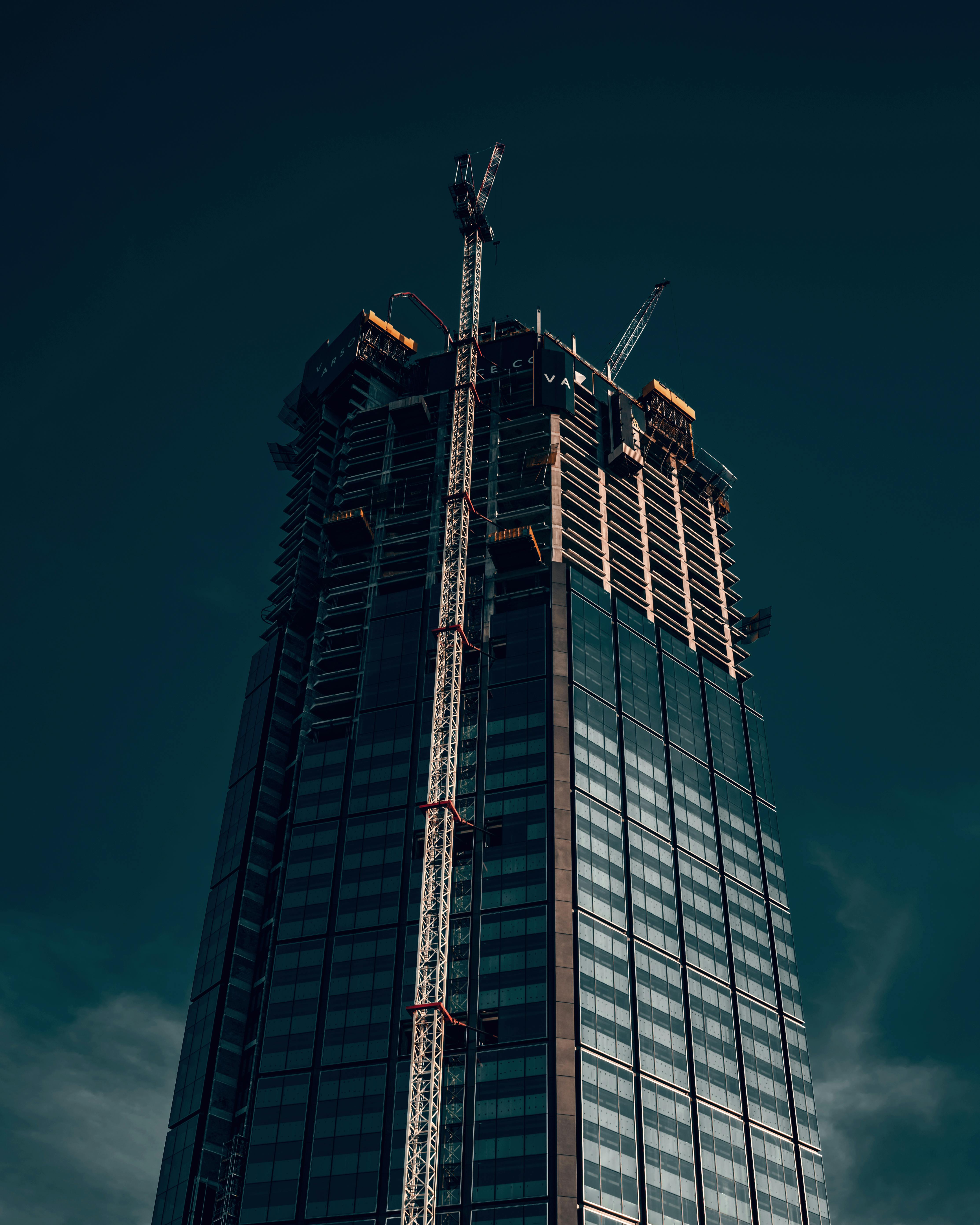 Low Angle Shot of Building Construction under Dark Sky · Free Stock Photo