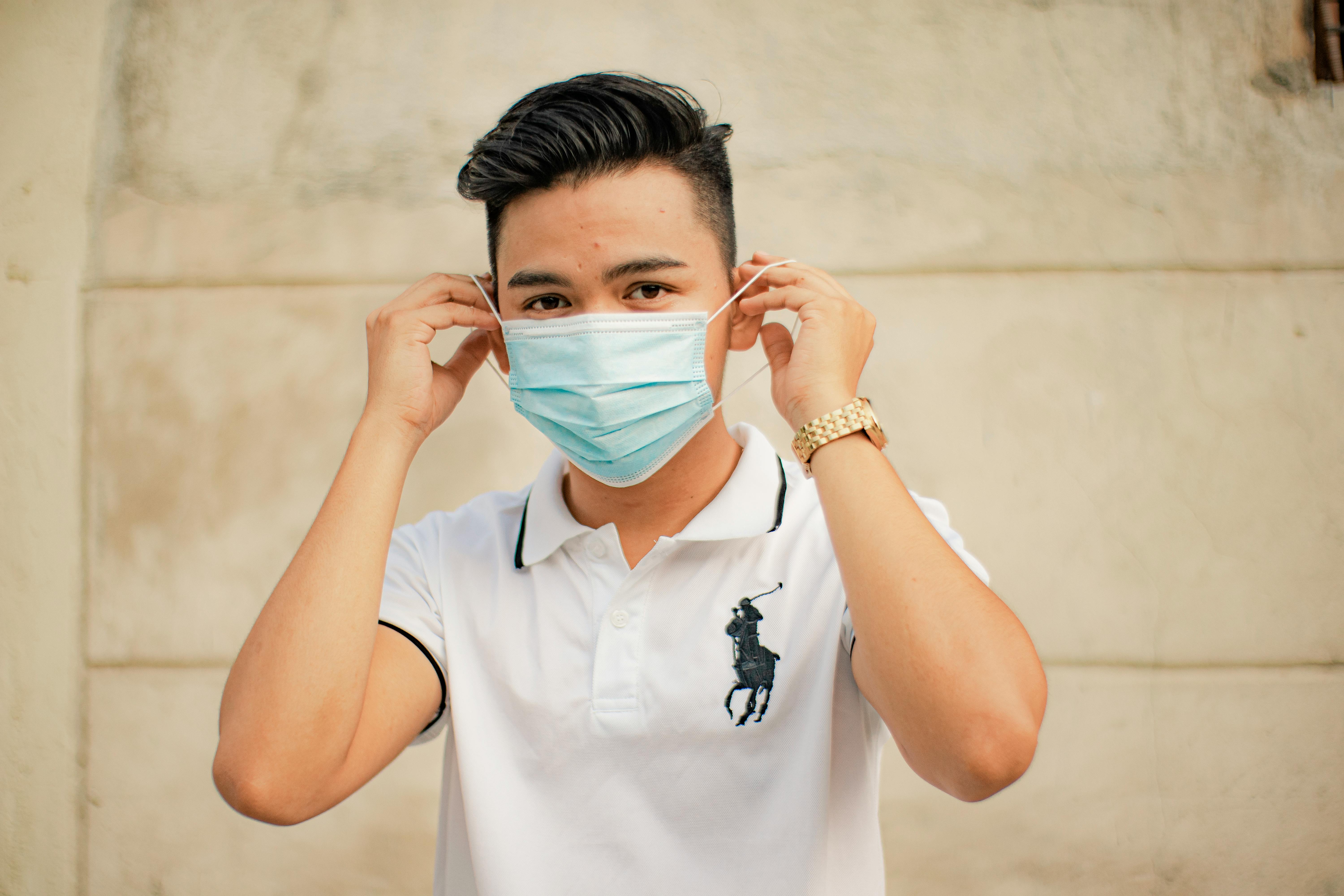 Man Putting on Face Mask · Free Stock Photo