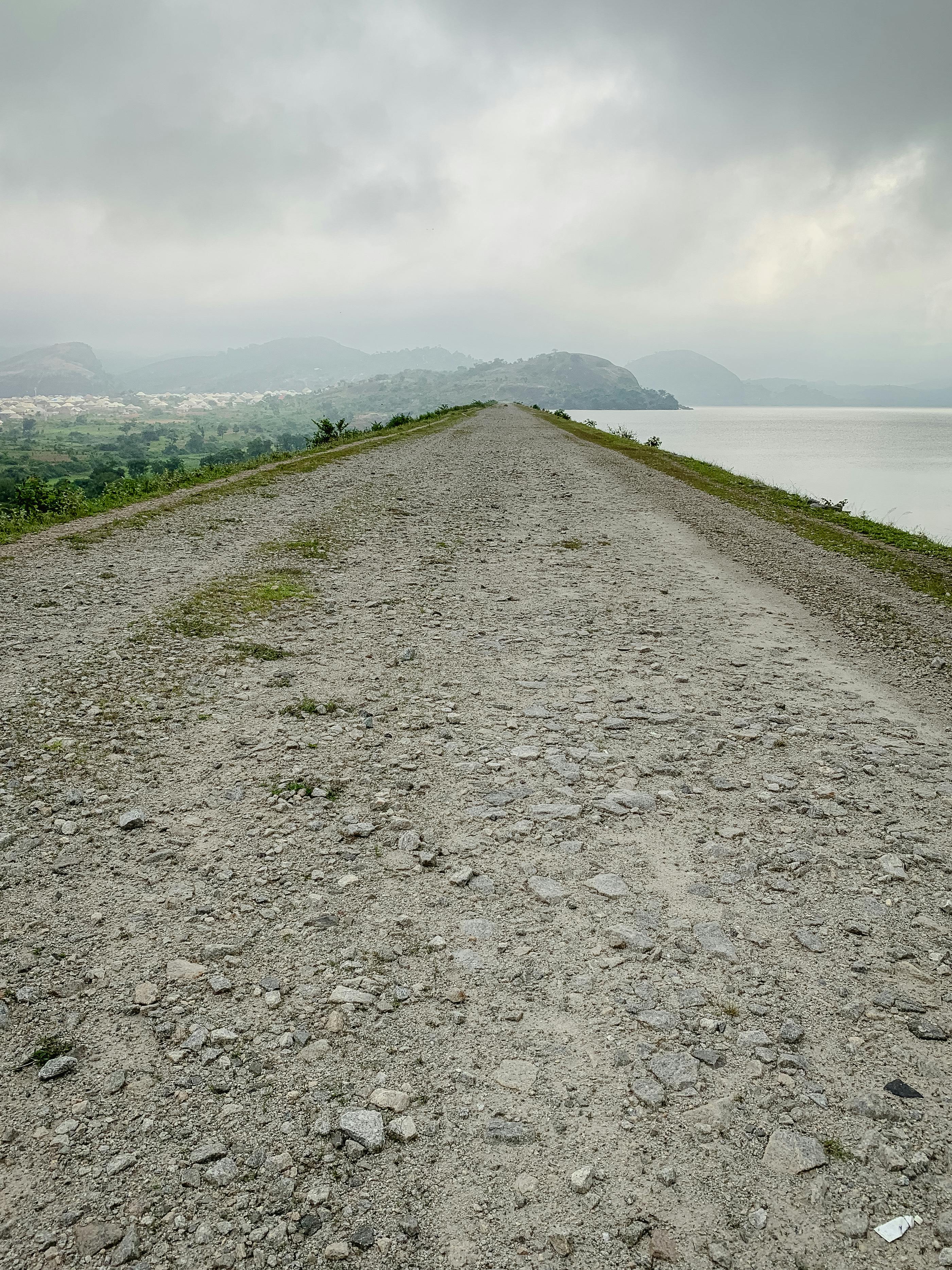 Gray Gravel Road Near the Body of Water · Free Stock Photo