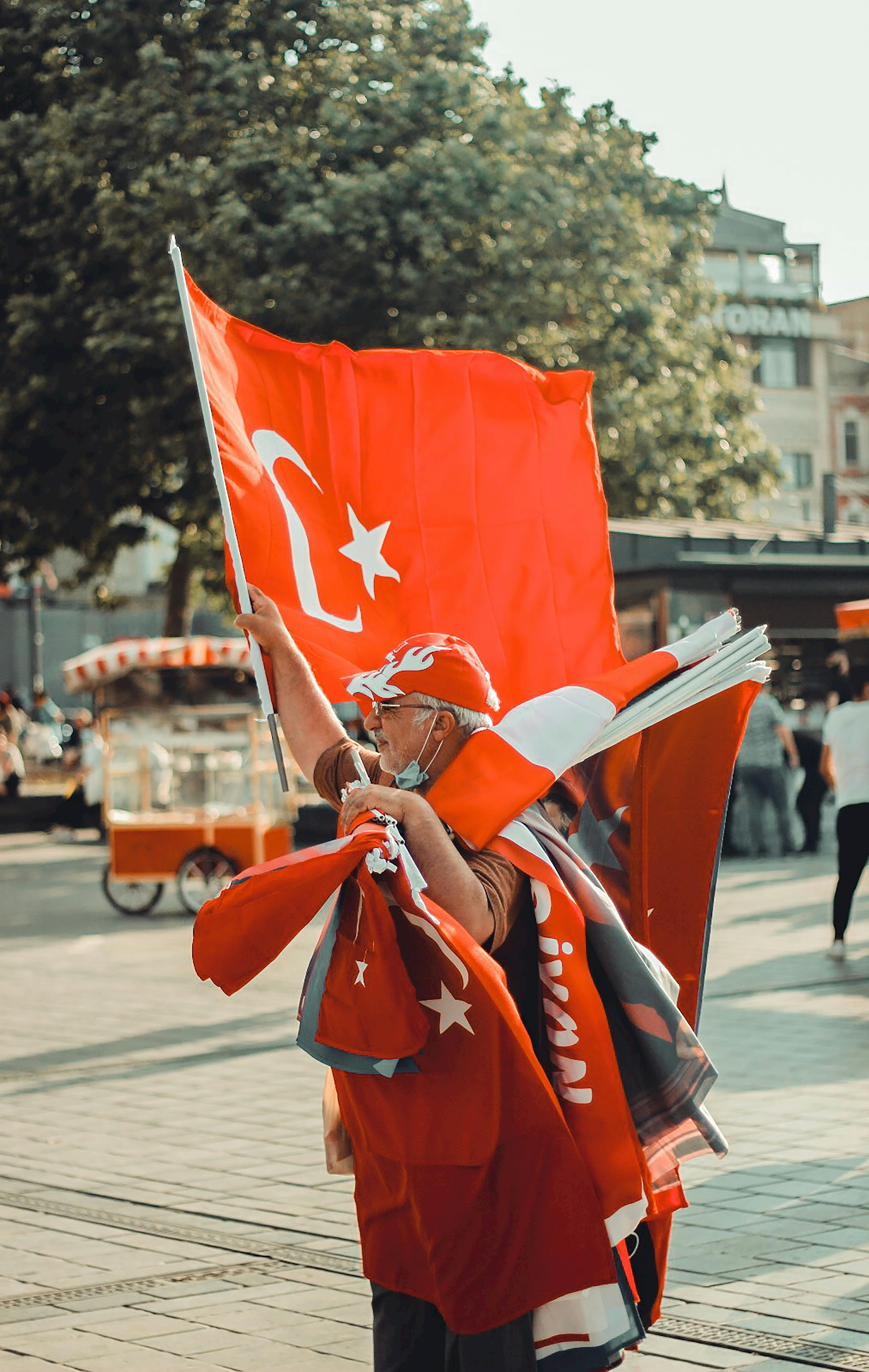 A Man Holding Turkish Flag on the Street · Free Stock Photo