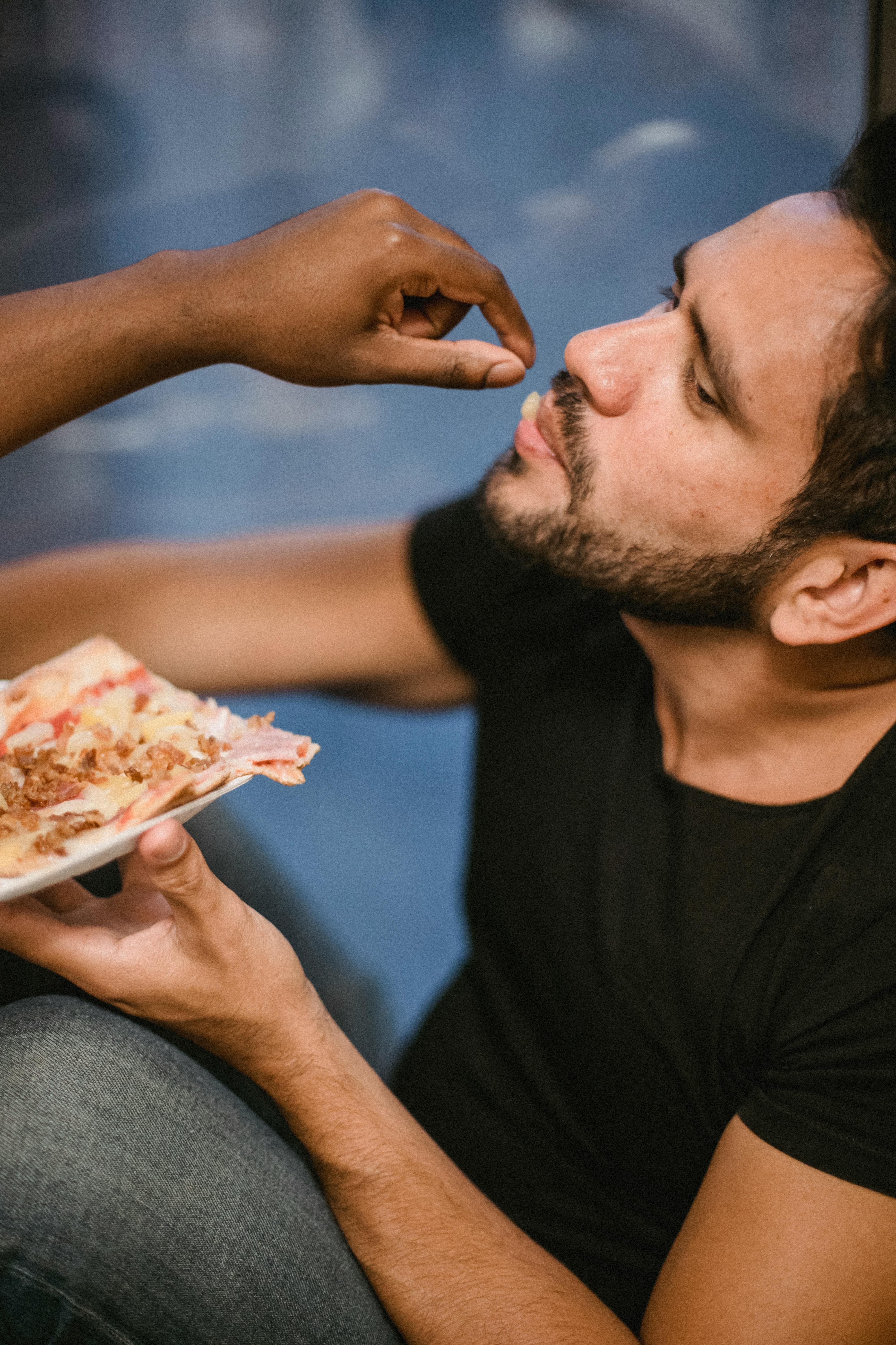 Men Feeding Each Other with Take Away Food · Free Stock Photo