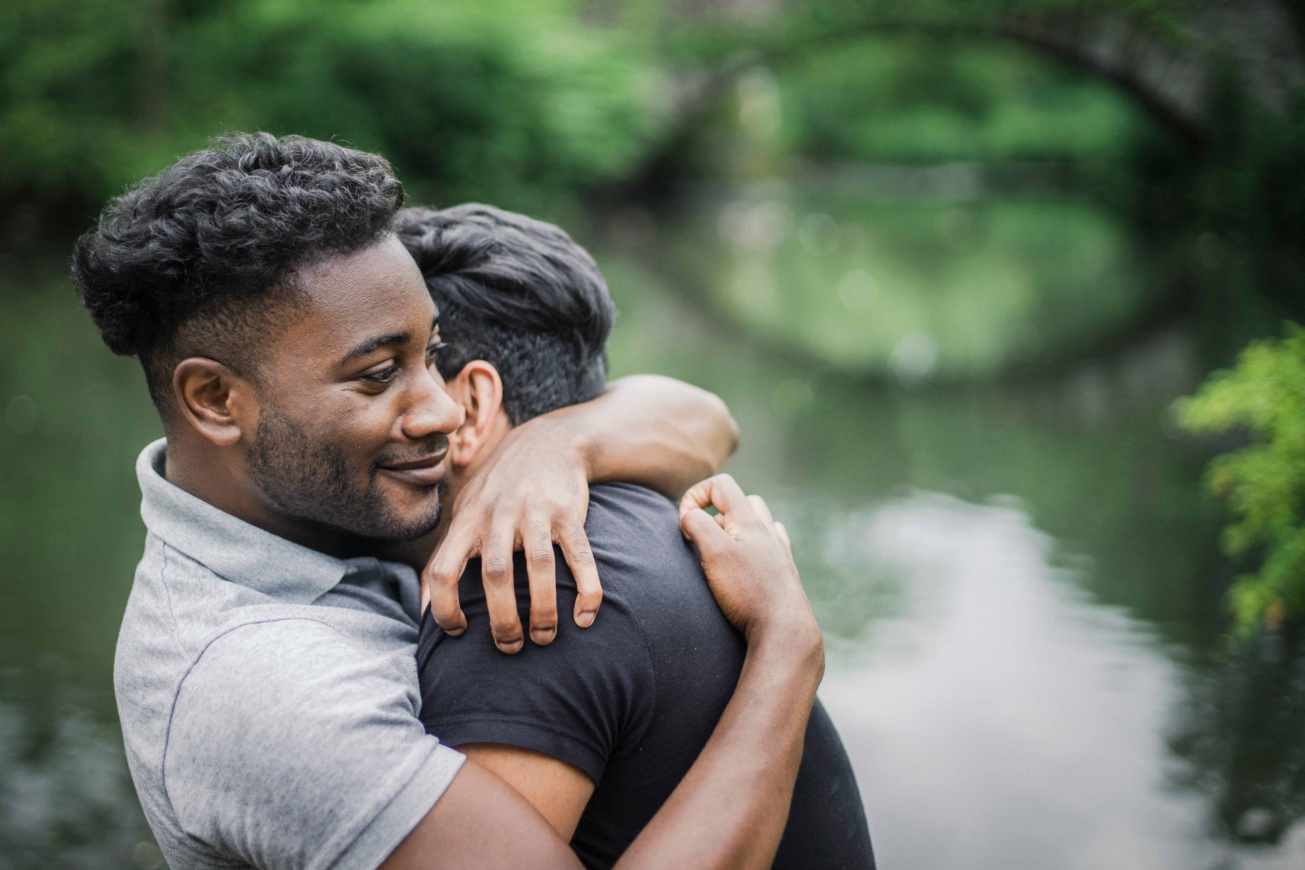 Couple Hugging by Water · Free Stock Photo