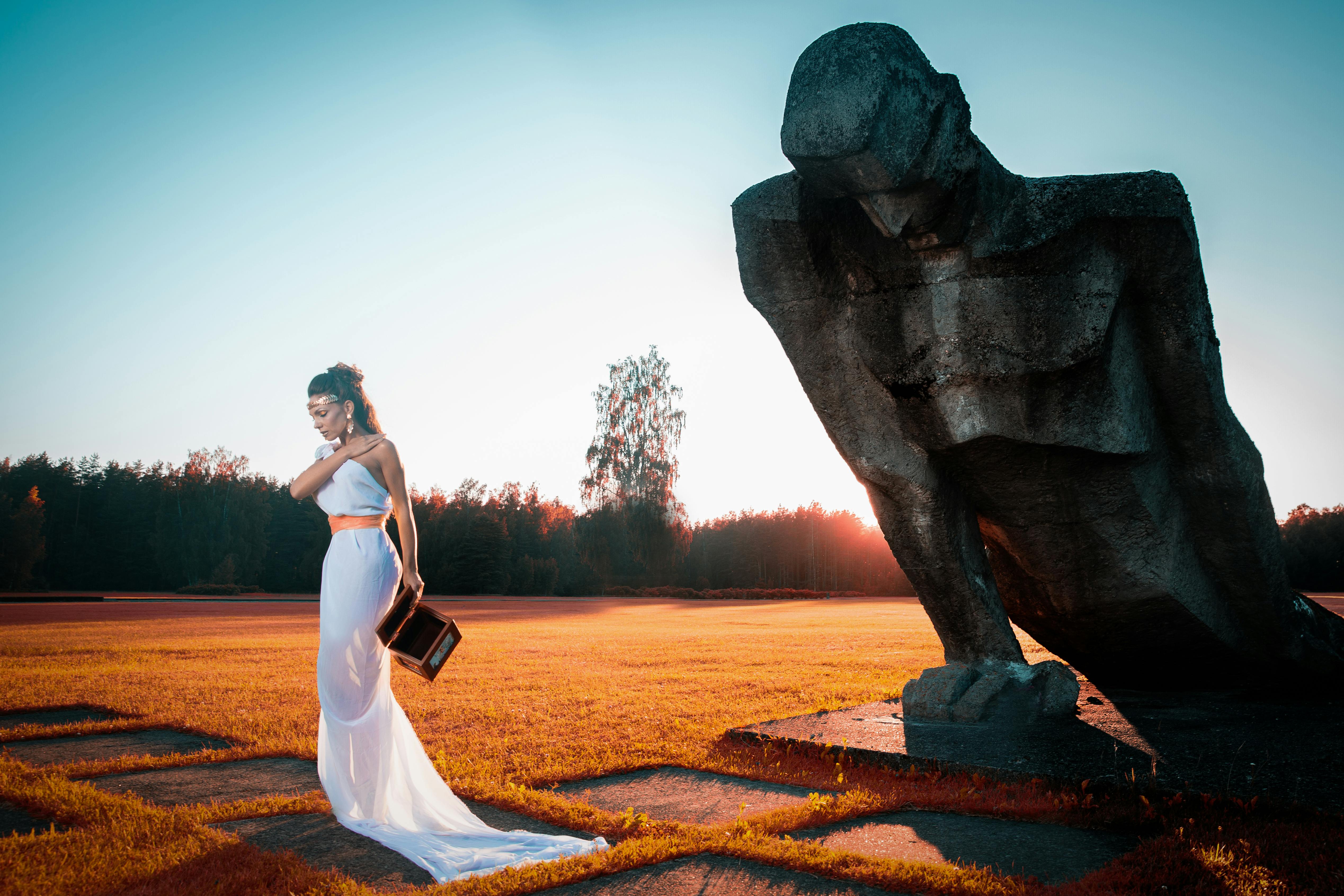 Woman in White Dress Near a Statue · Free Stock Photo