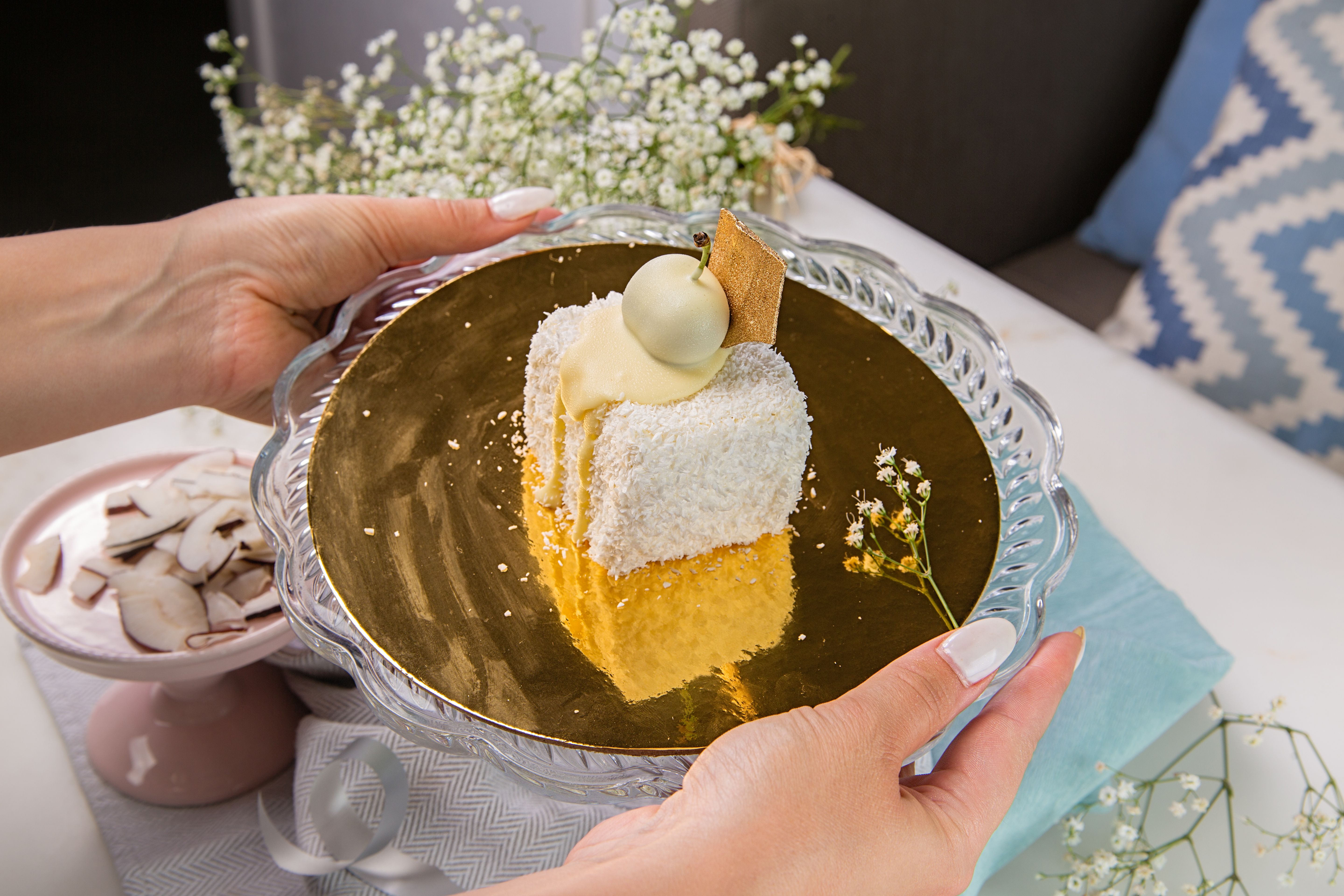 Hands of a Person Holding a Cake on a Plate · Free Stock Photo