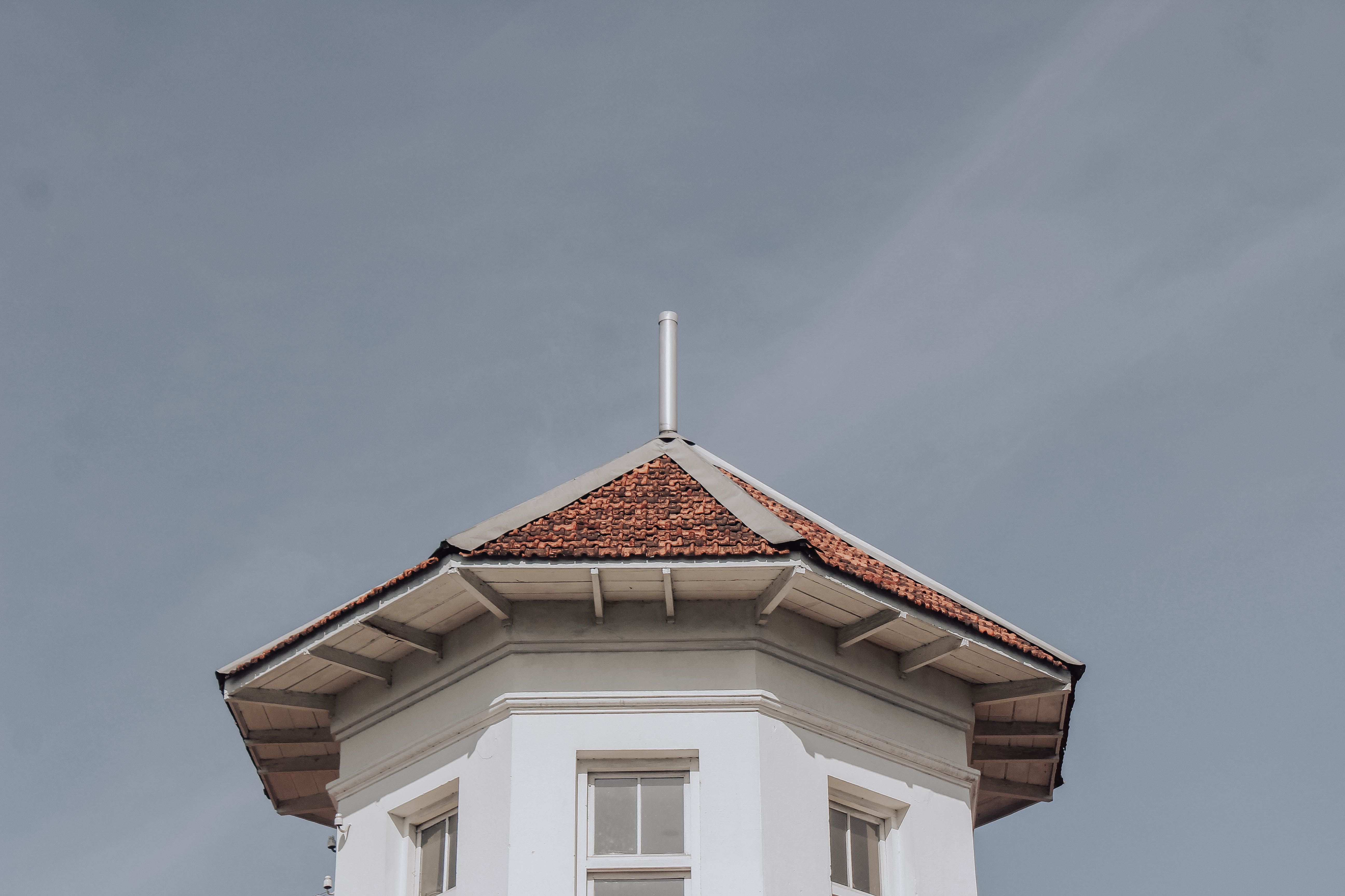 An Old Blue Concrete Building with Roof Tiles · Free Stock Photo