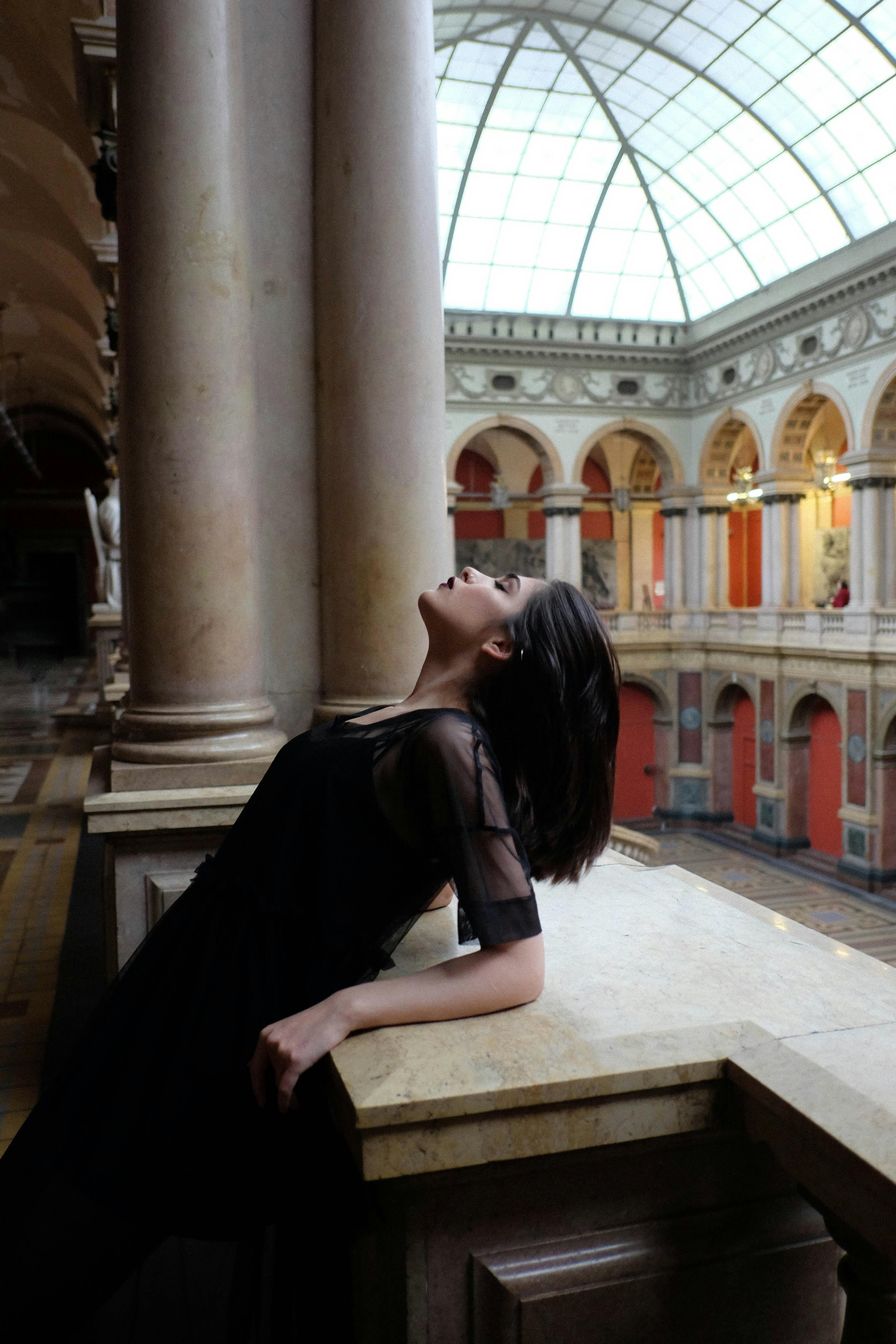 Gorgeous model in trendy clothes on fenced balcony in building · Free ...