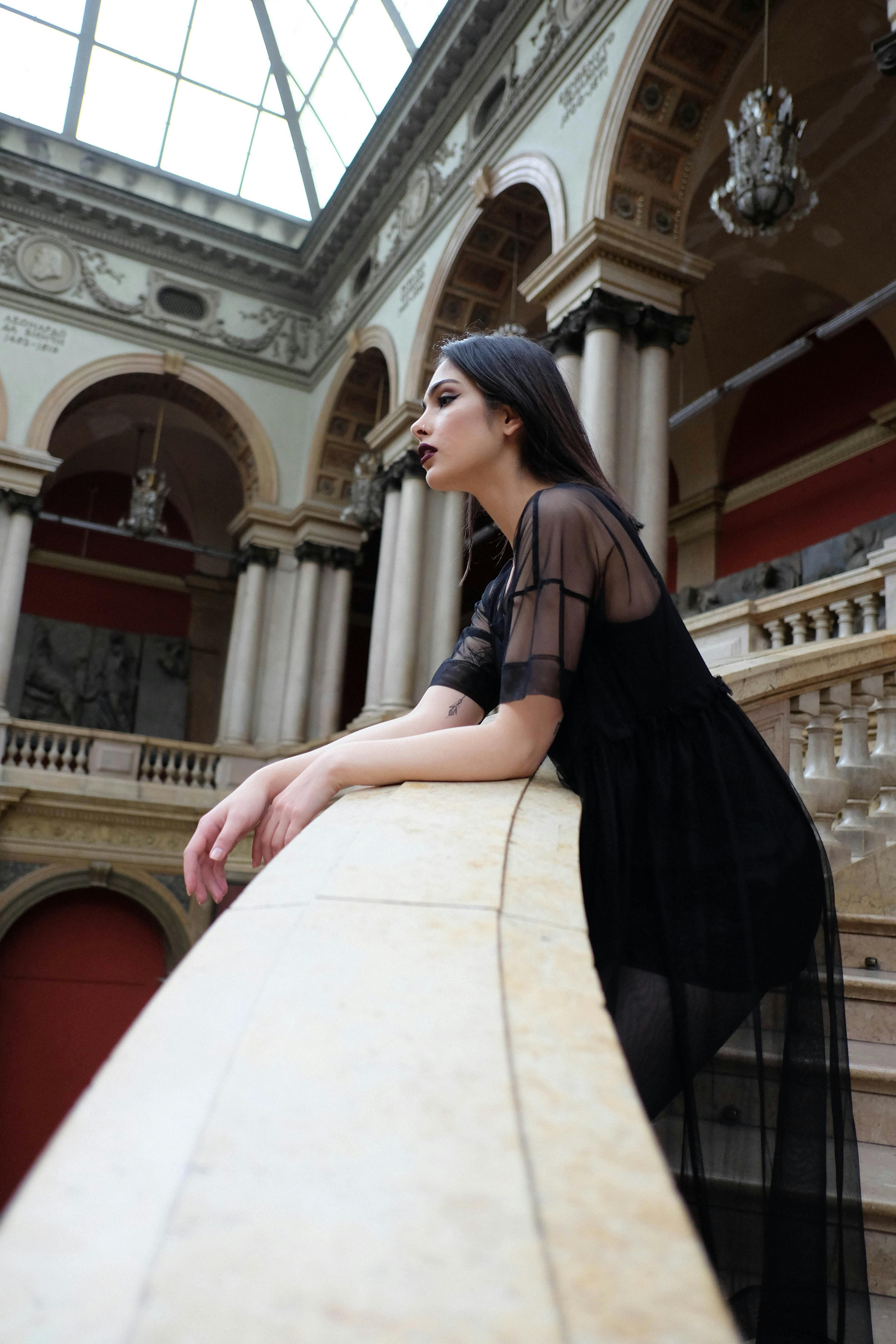 Woman in black elegant dress standing on stairs in palace · Free Stock ...