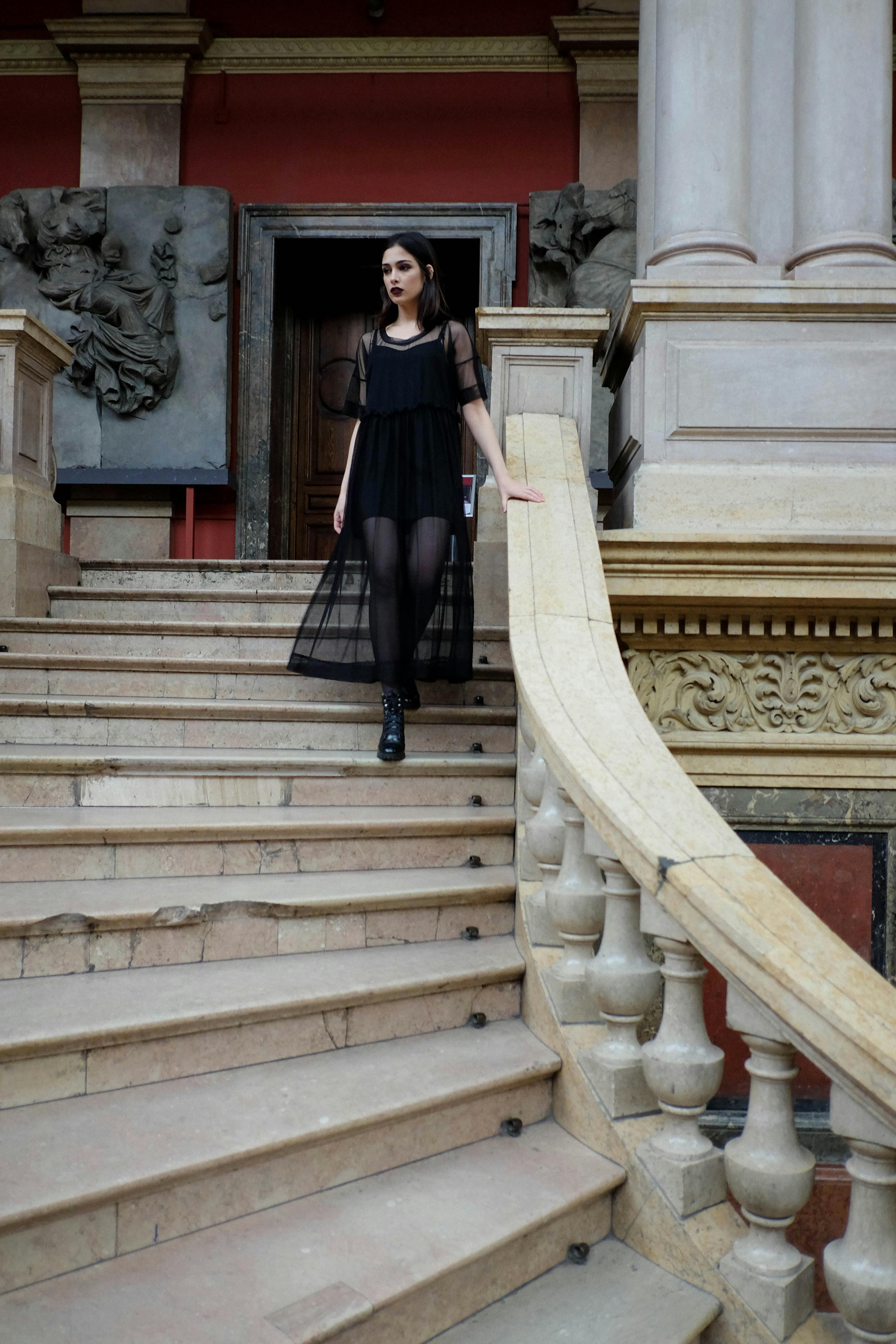 Emotionless woman in Gothic outfit walking downstairs in palace · Free ...