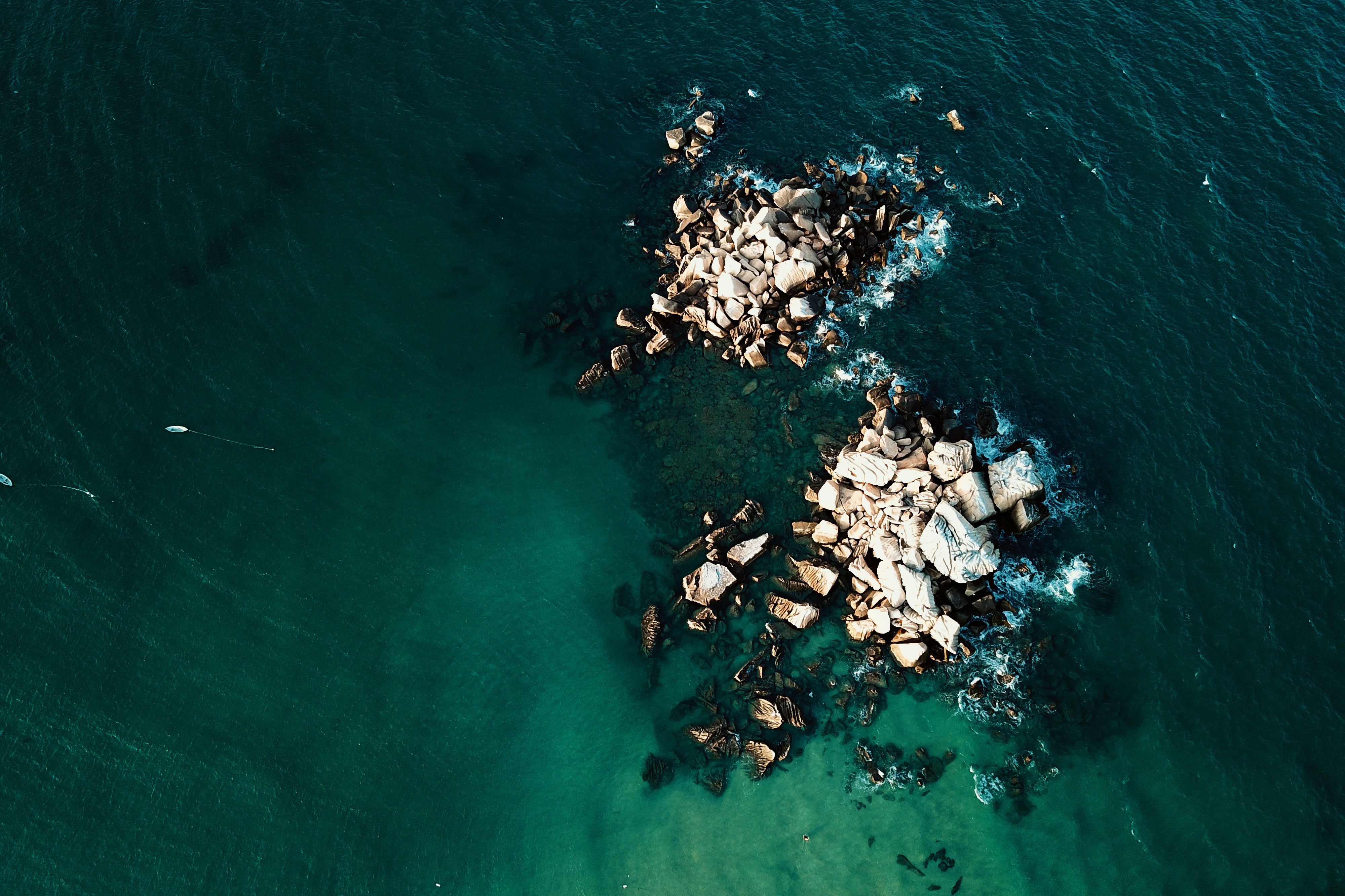 Rough rocks near sea with pure water · Free Stock Photo