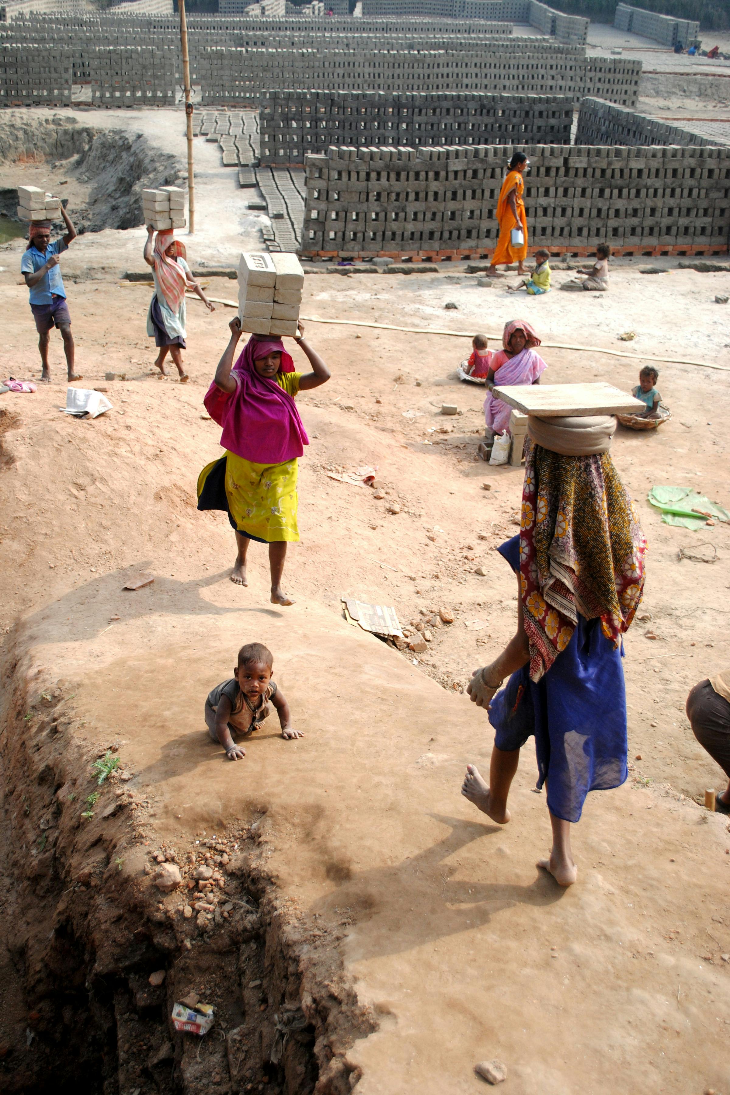 Women Carrying Blocks on Heads in Village · Free Stock Photo