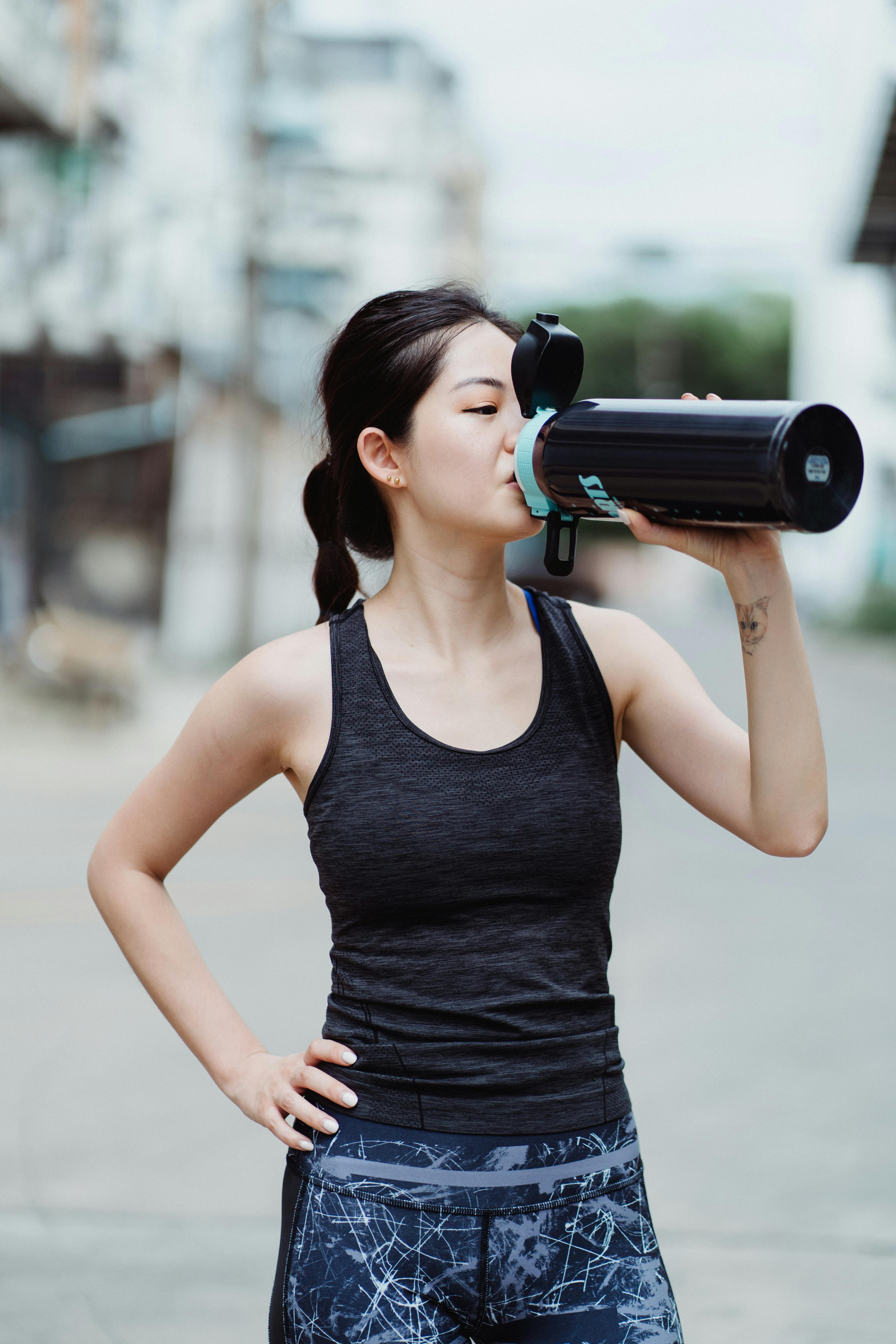 Portrait of a Woman Drinking Water · Free Stock Photo
