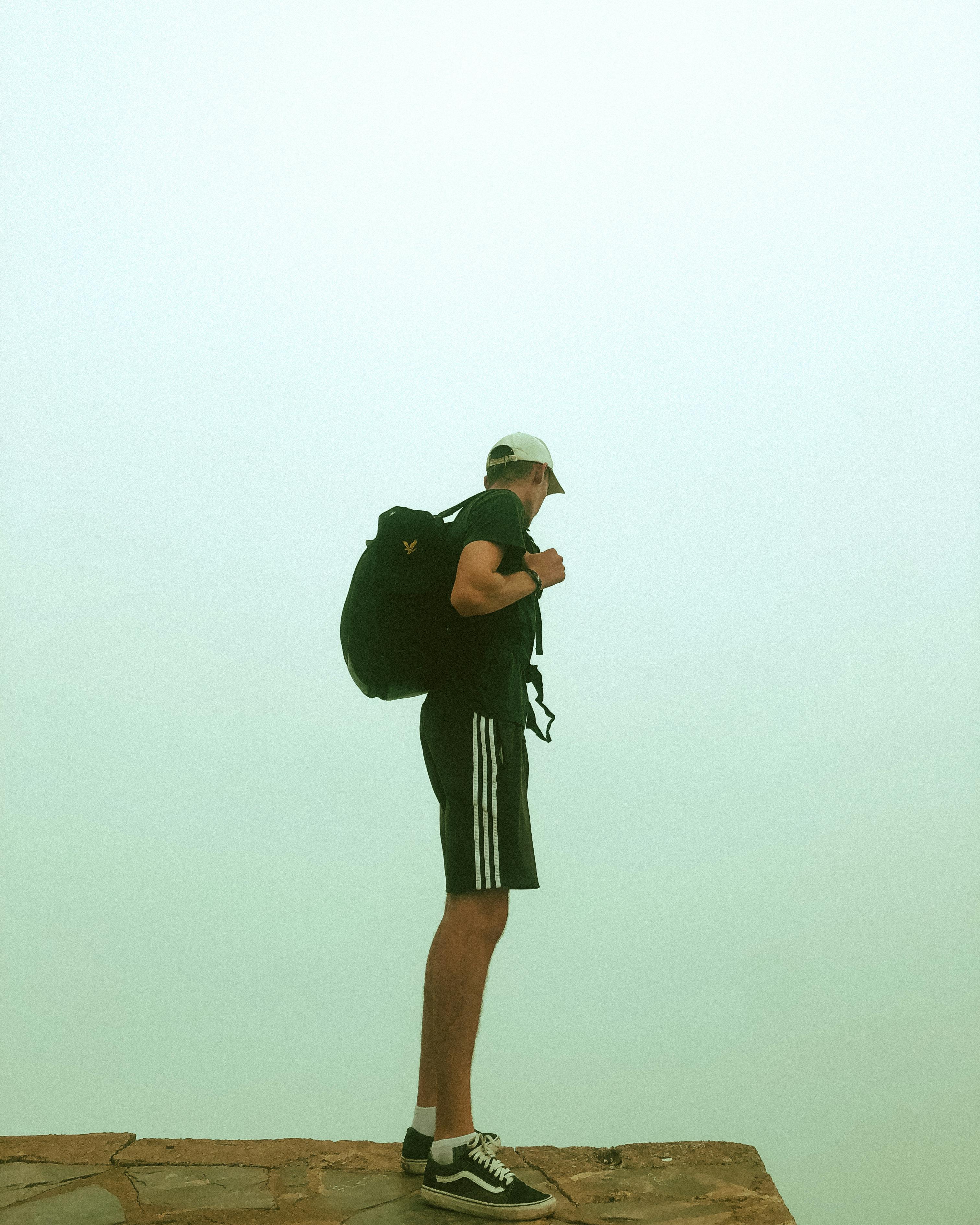 Photo of a Boy with a Cap Looking Down · Free Stock Photo