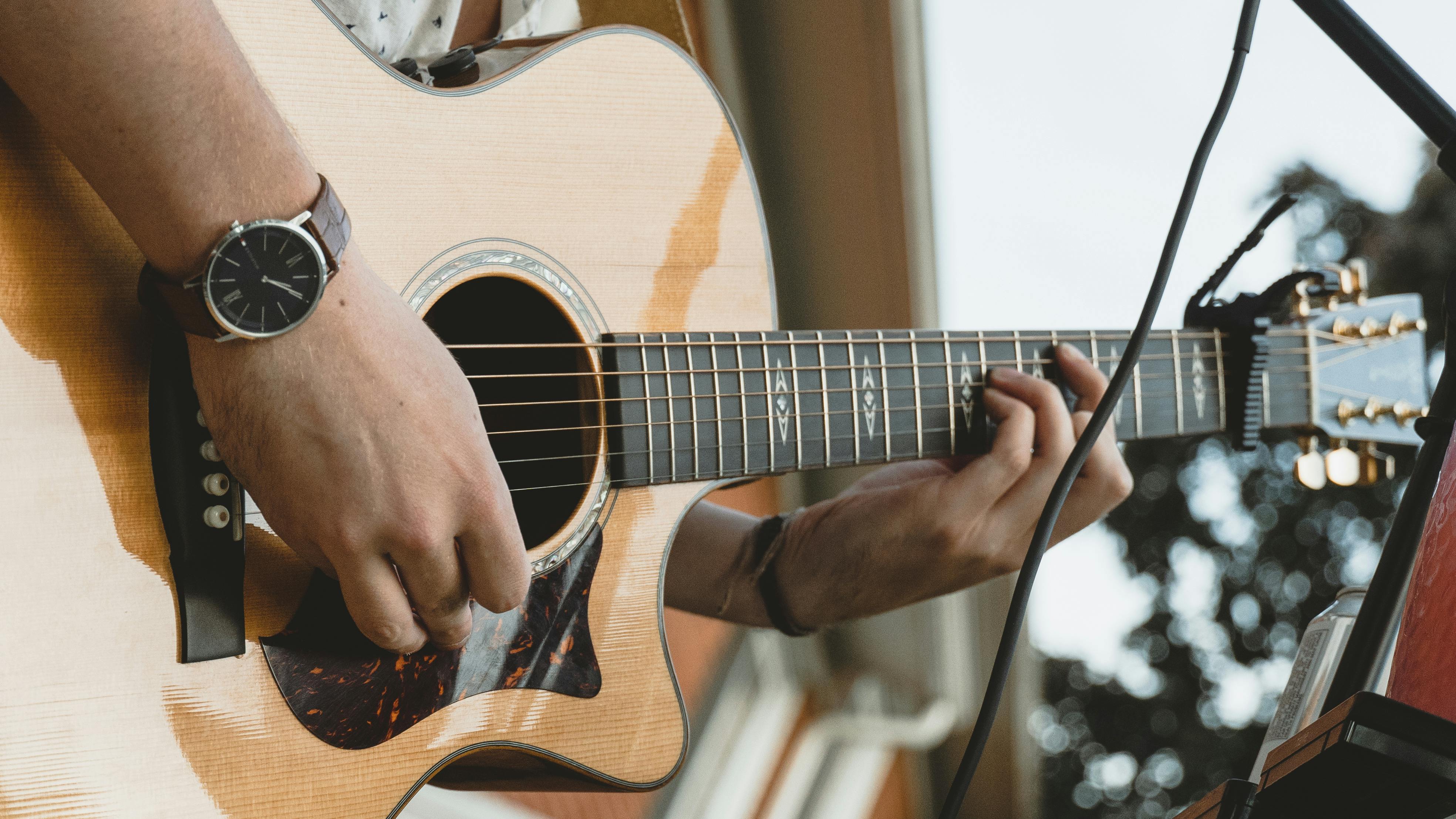 Guitarist Hand in Close-up View · Free Stock Photo