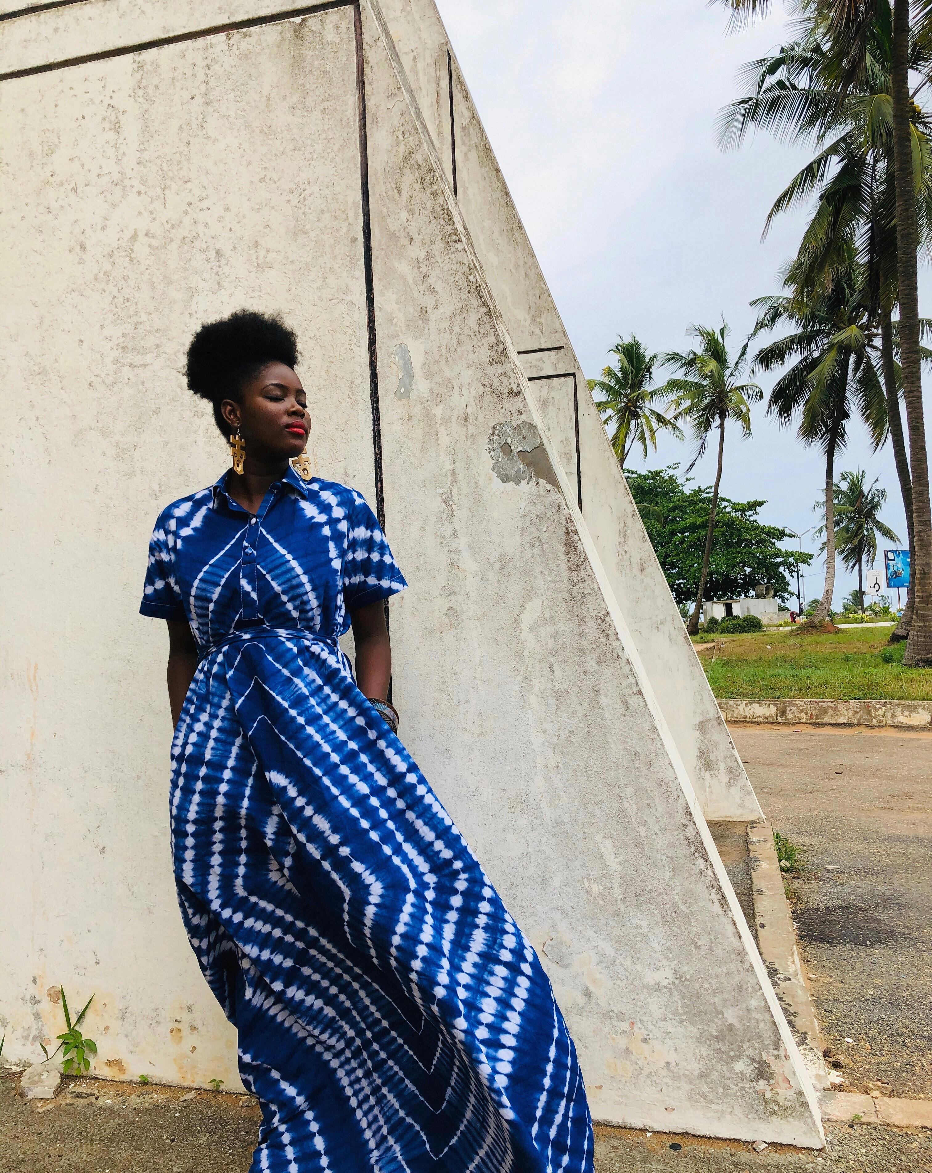 A Woman in Blue Dress Standing on Ground Soil · Free Stock Photo