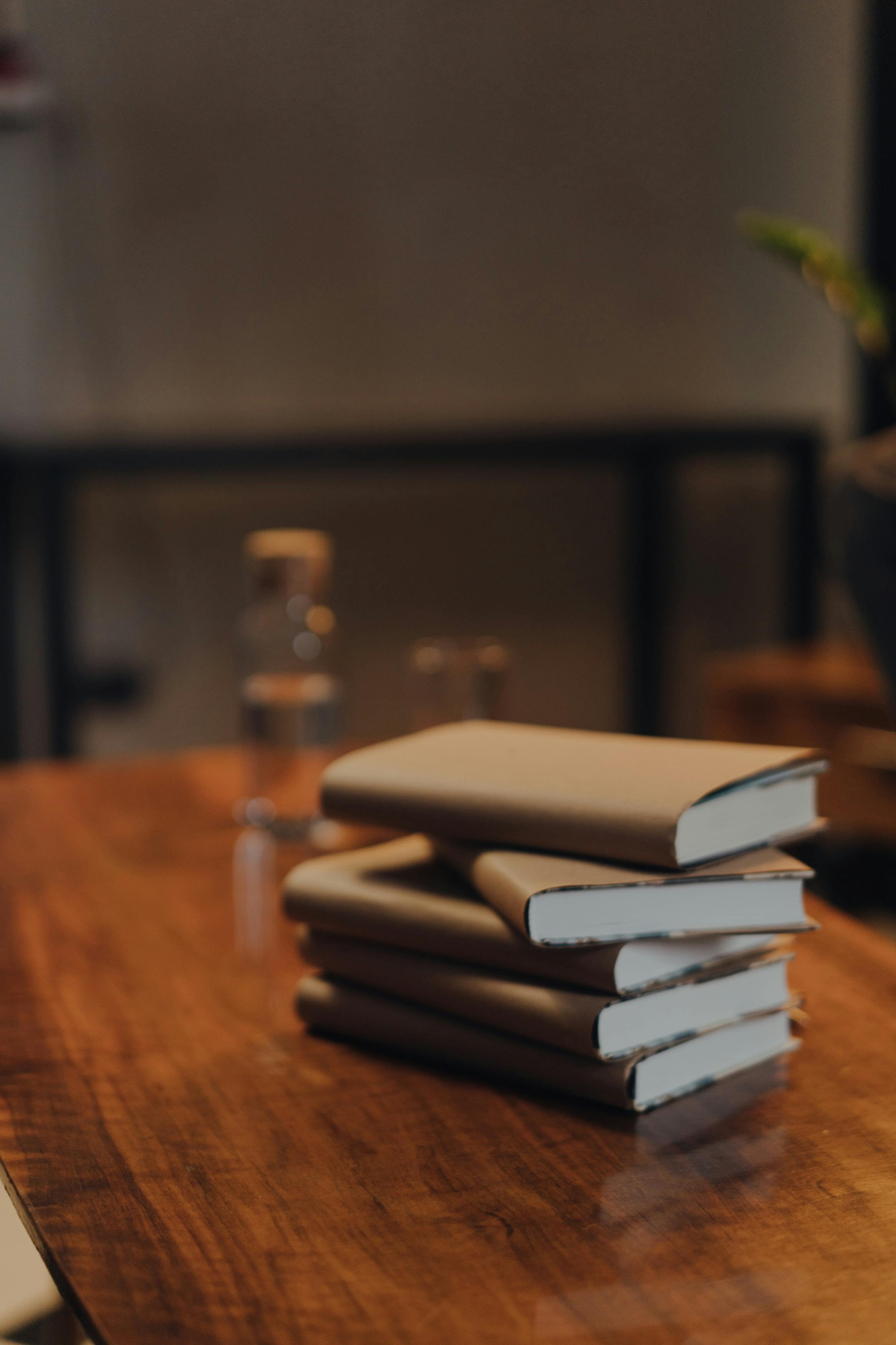 Blooming Magnolia Flowers on Stack of Books · Free Stock Photo