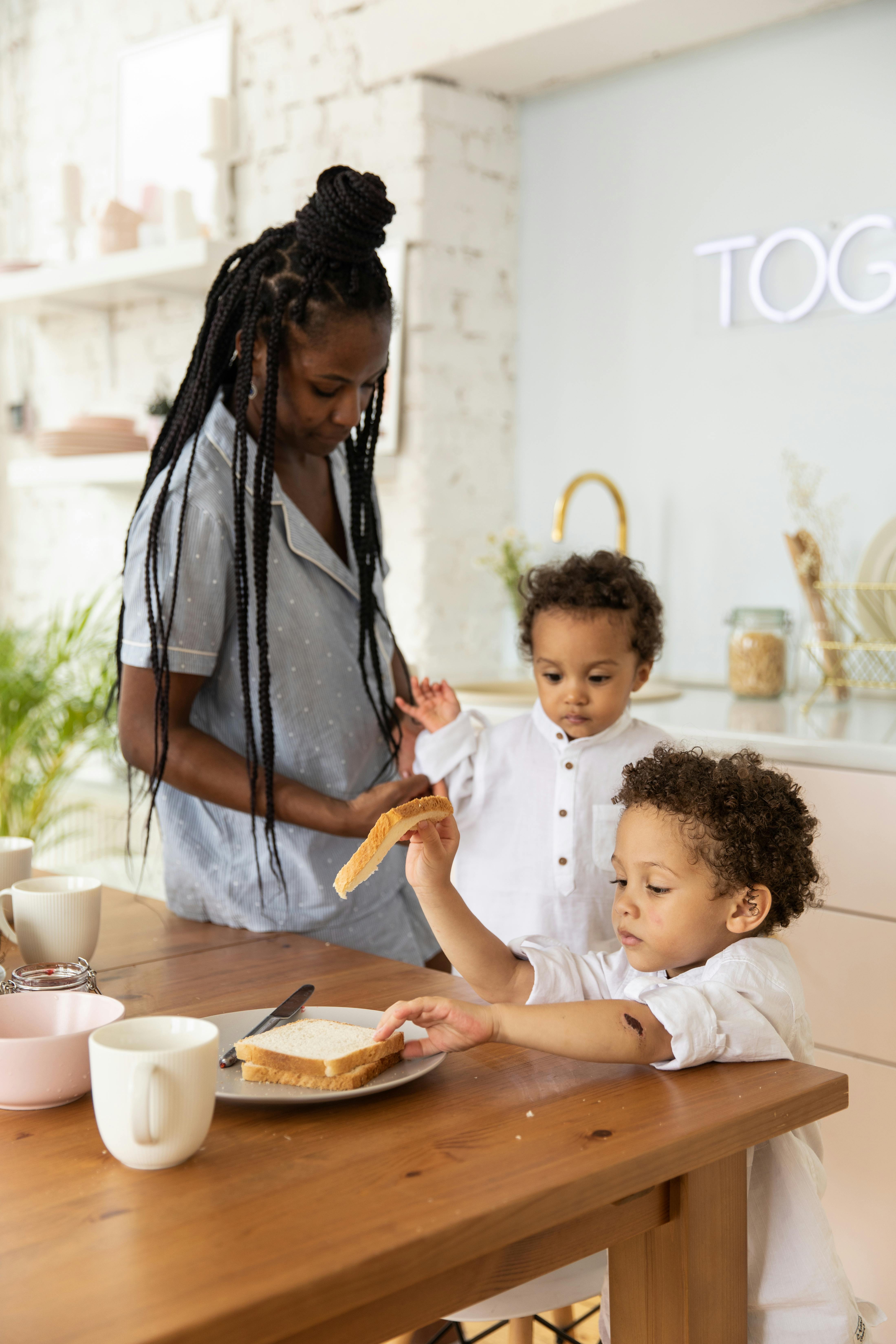Woman Giving Food to her Kids · Free Stock Photo