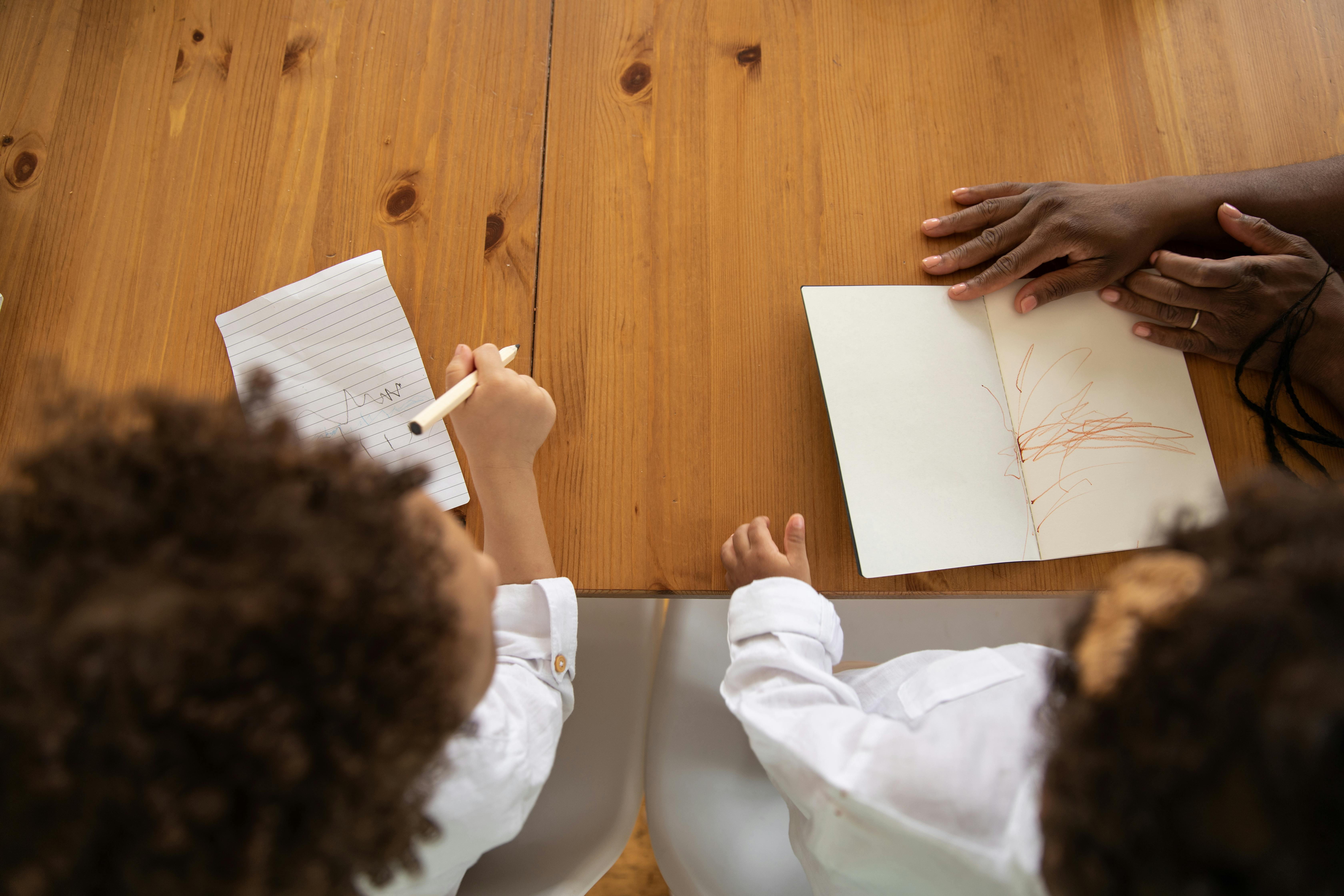 Children Writing on Paper · Free Stock Photo