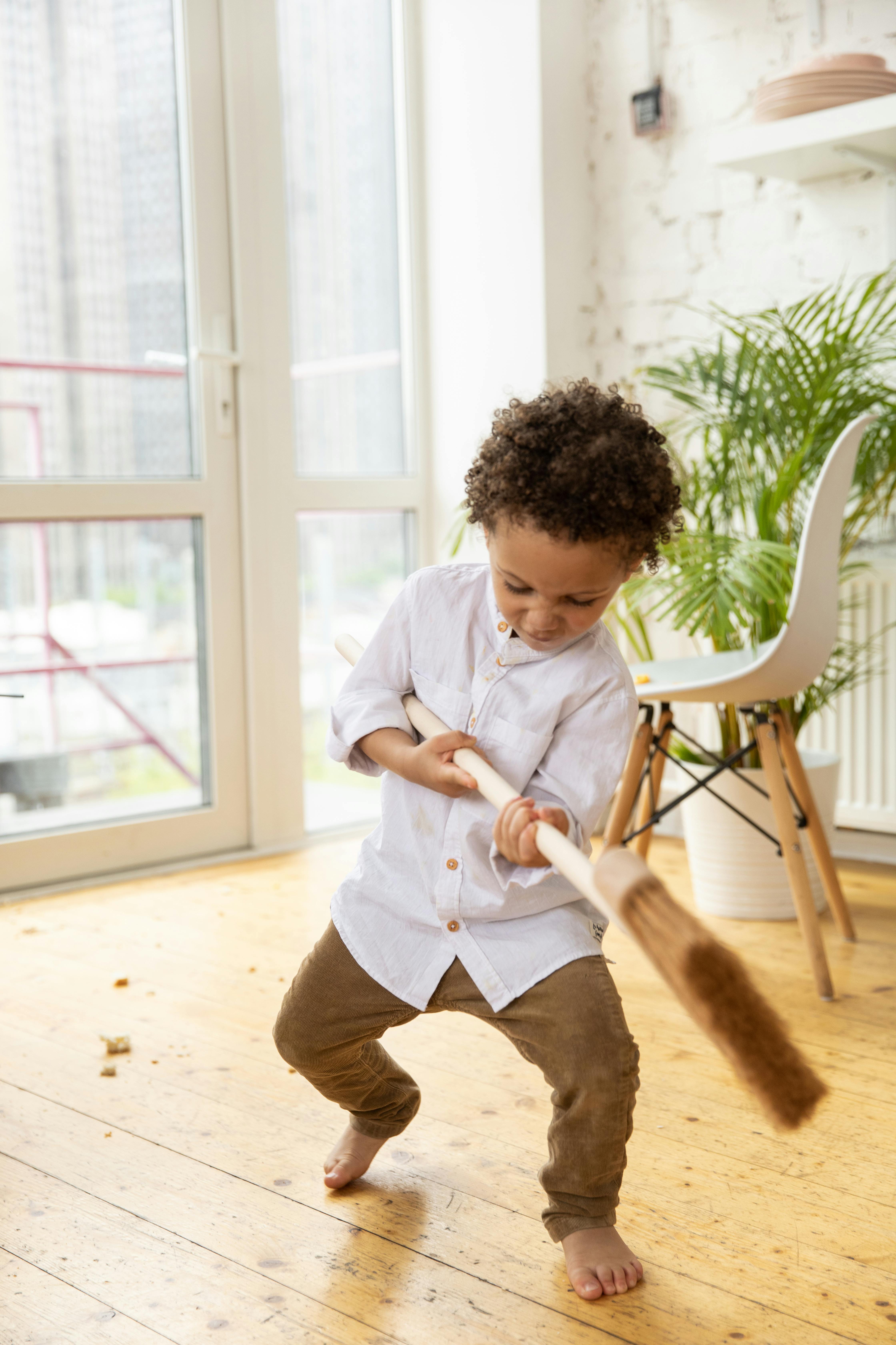Child Playing with Broom · Free Stock Photo