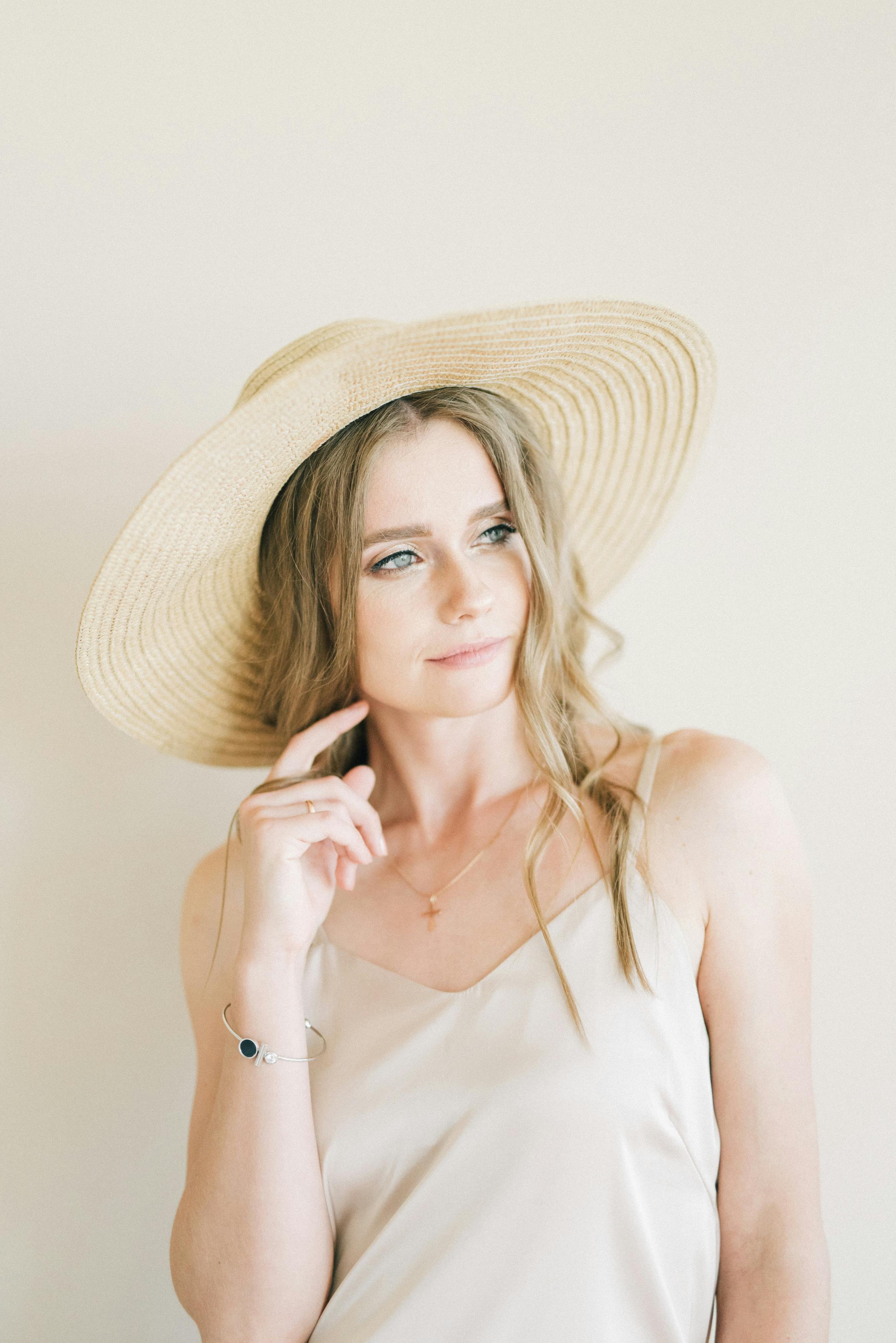 A Woman Wearing a Straw Hat · Free Stock Photo