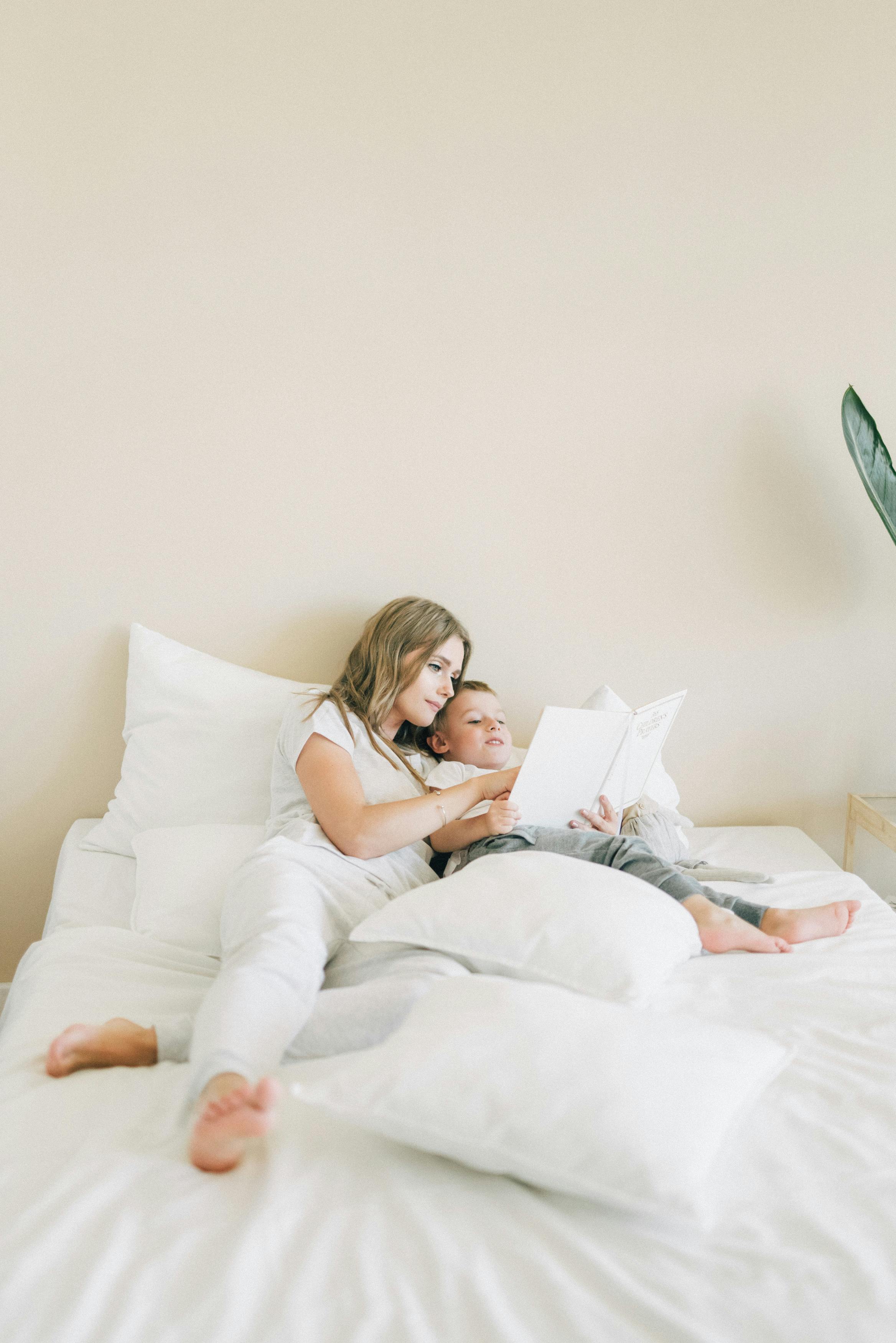 Photo of a Woman Reading a Book while Stretching · Free Stock Photo
