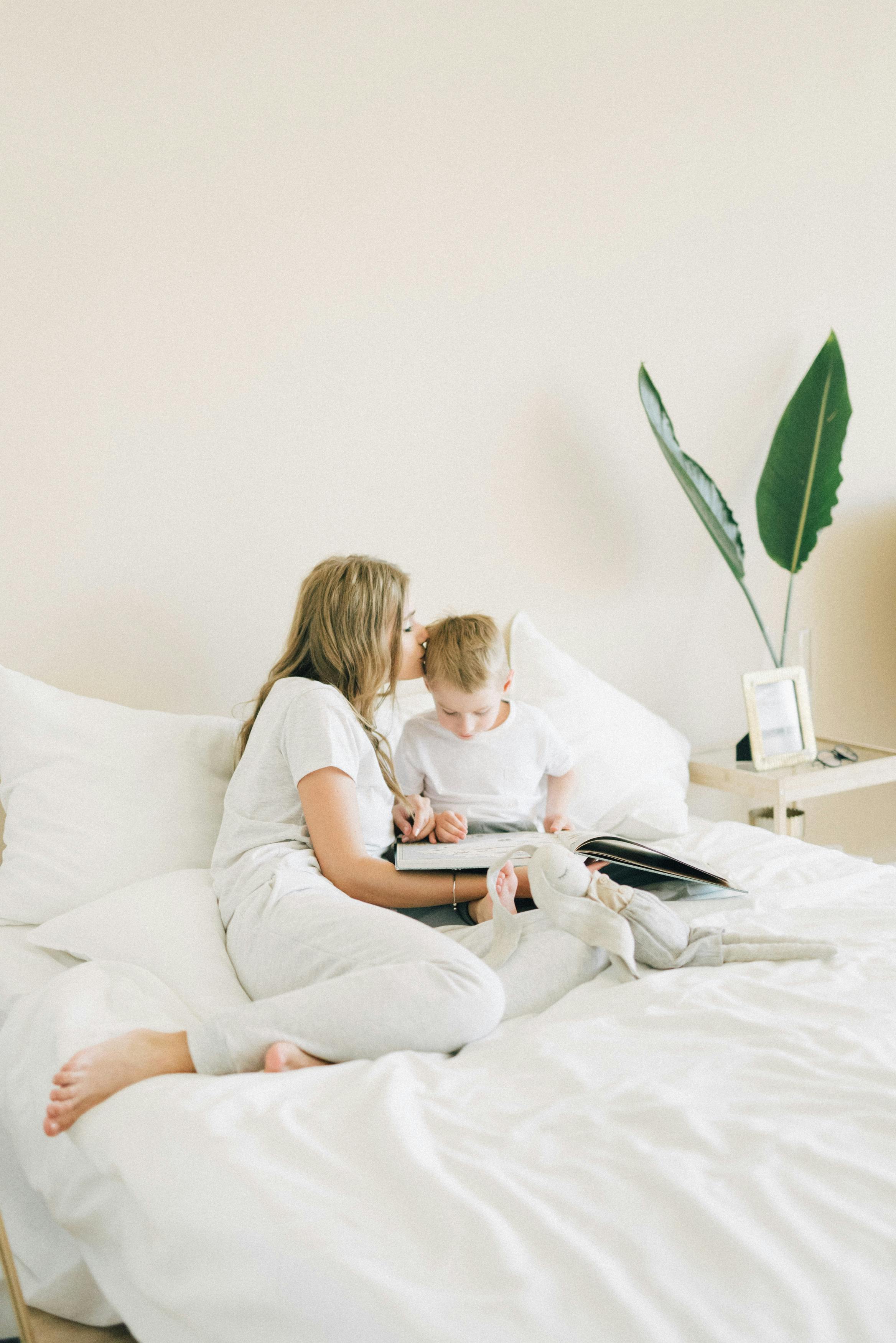 Photo of a Woman Reading a Book while Stretching · Free Stock Photo