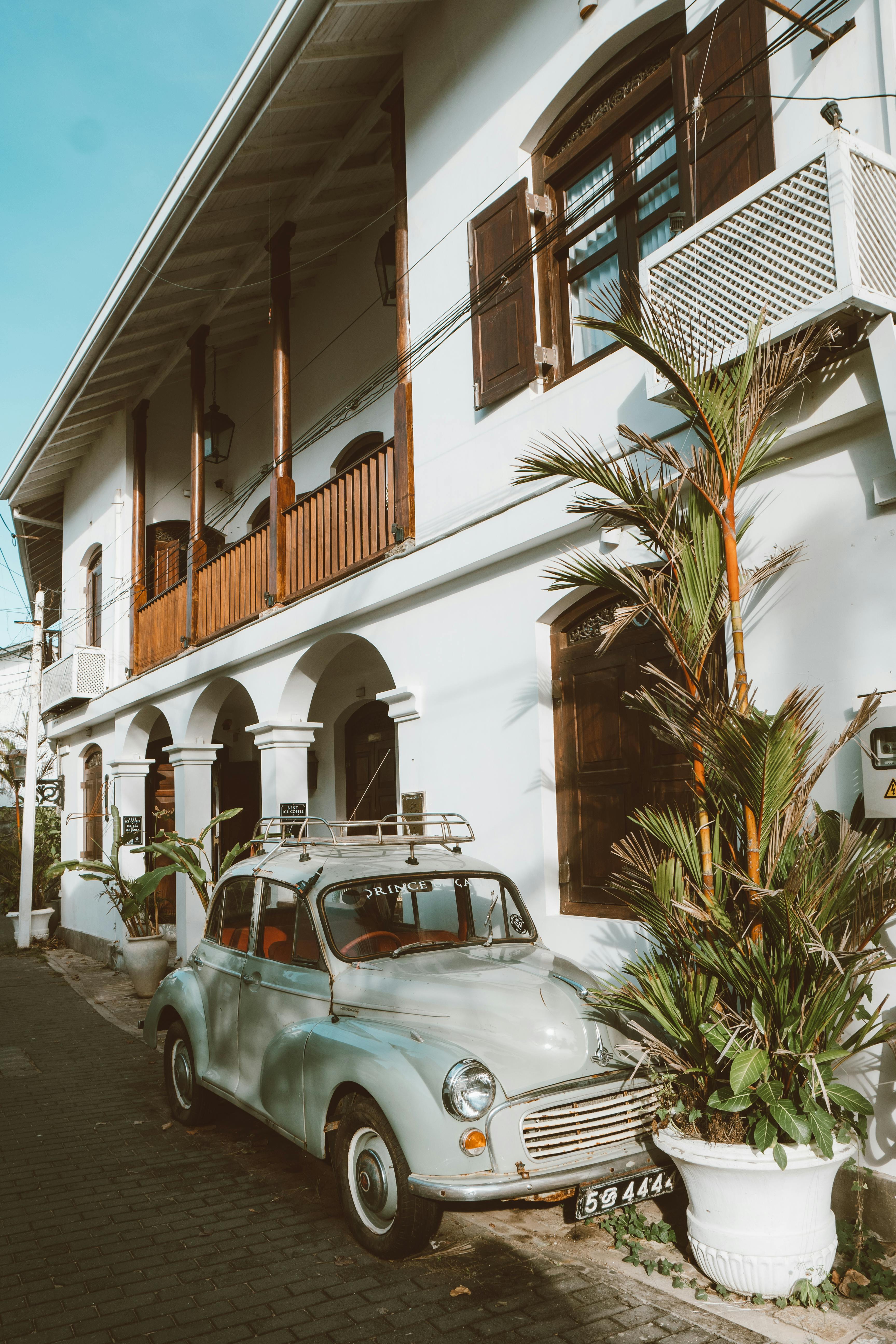 Classic Car parked outside an Old House · Free Stock Photo