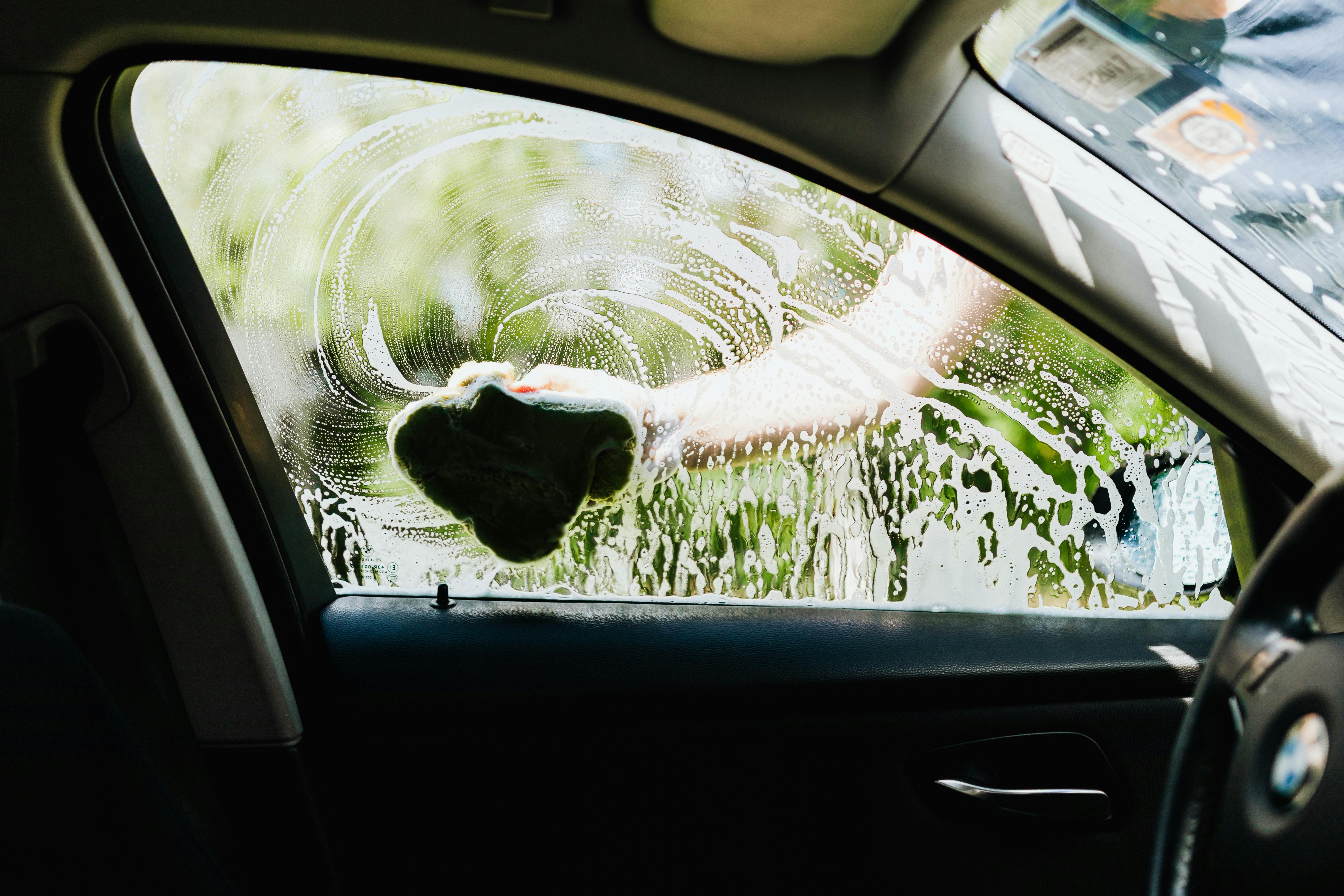 A Person Washing a Car Window · Free Stock Photo