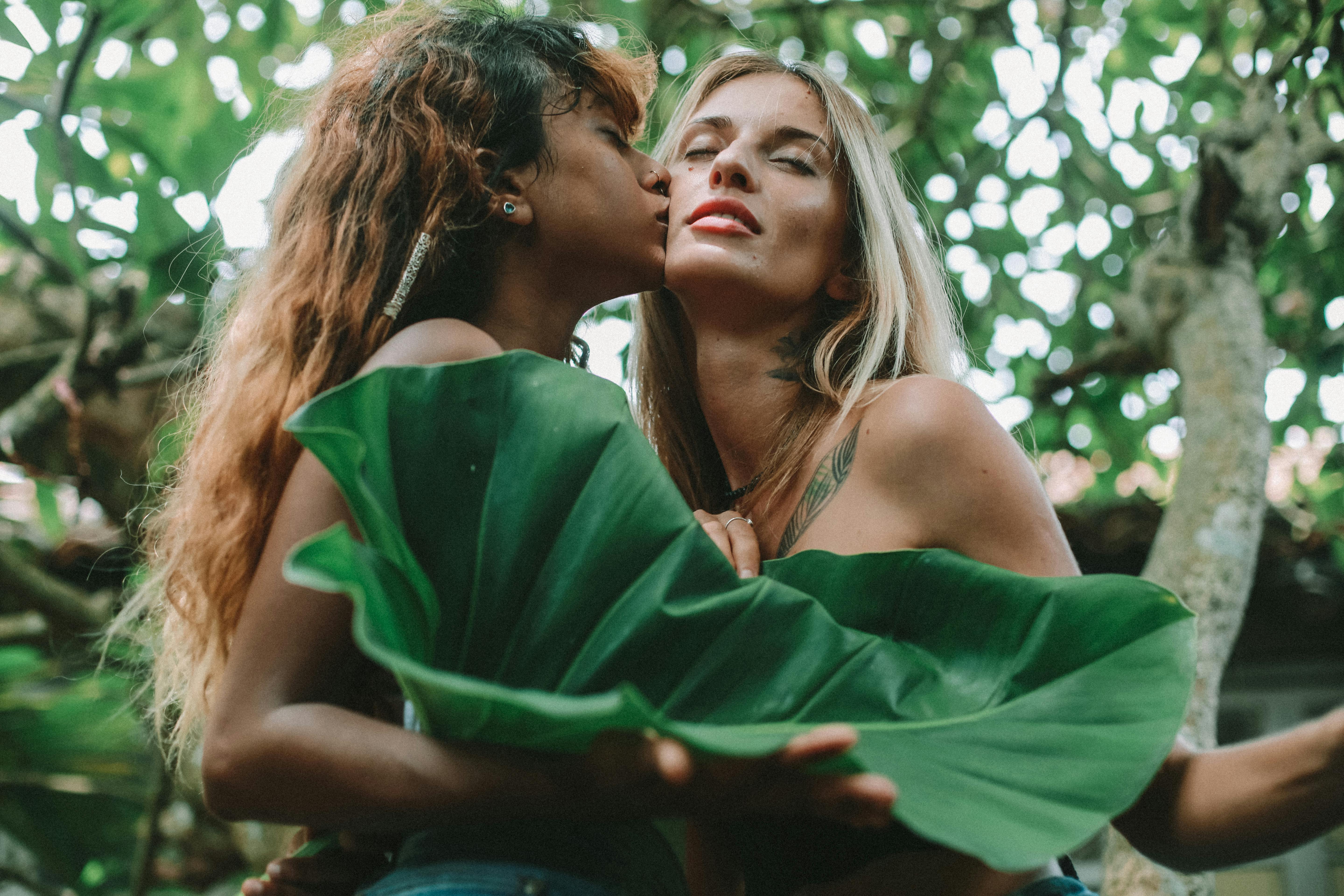 Photo of a Woman Kissing Another Woman on the Cheek · Free Stock Photo