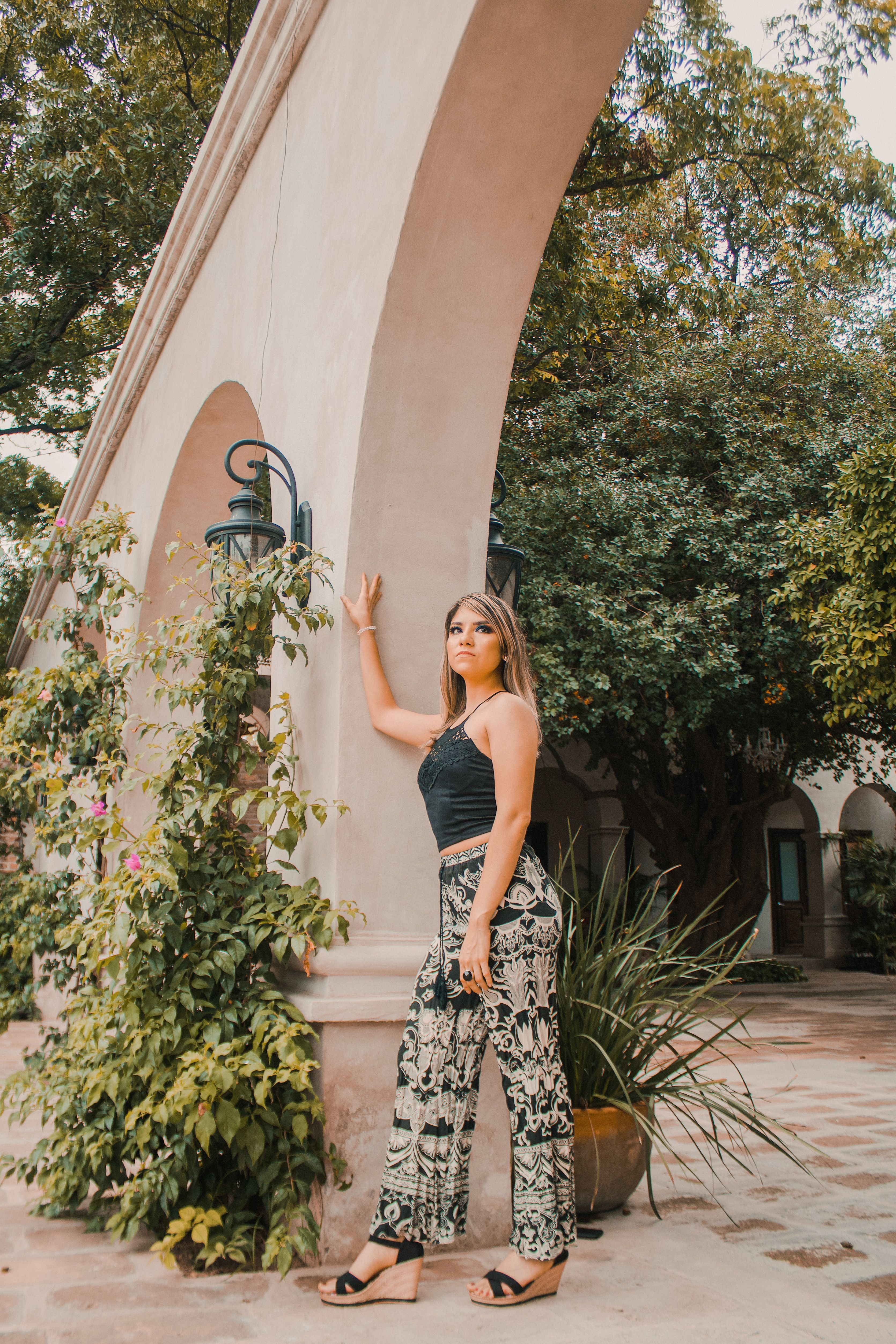 Gorgeous woman leaning to arch · Free Stock Photo