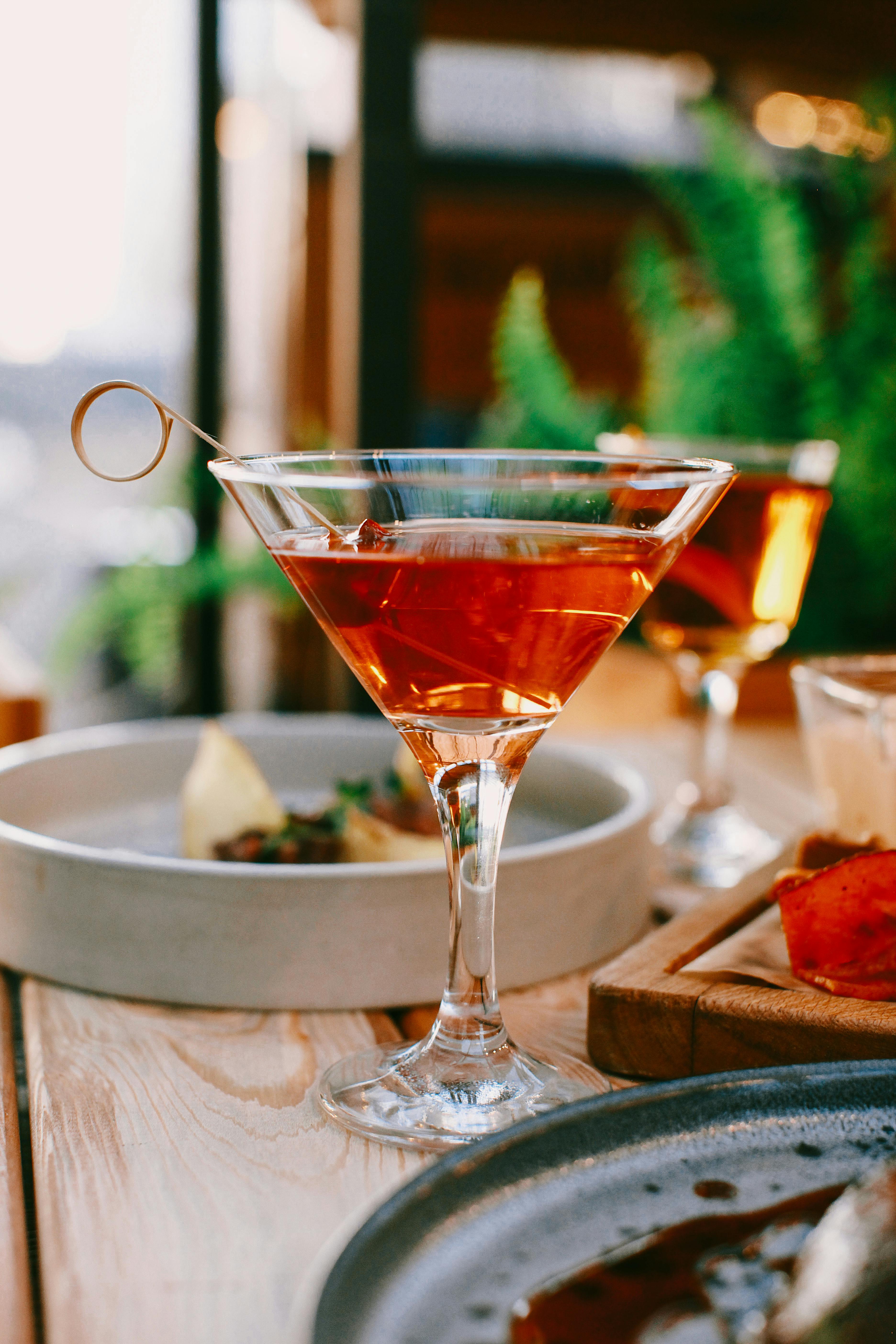 Close-up of a Red Cocktail on a Restaurant Table Among Other Dishes ...