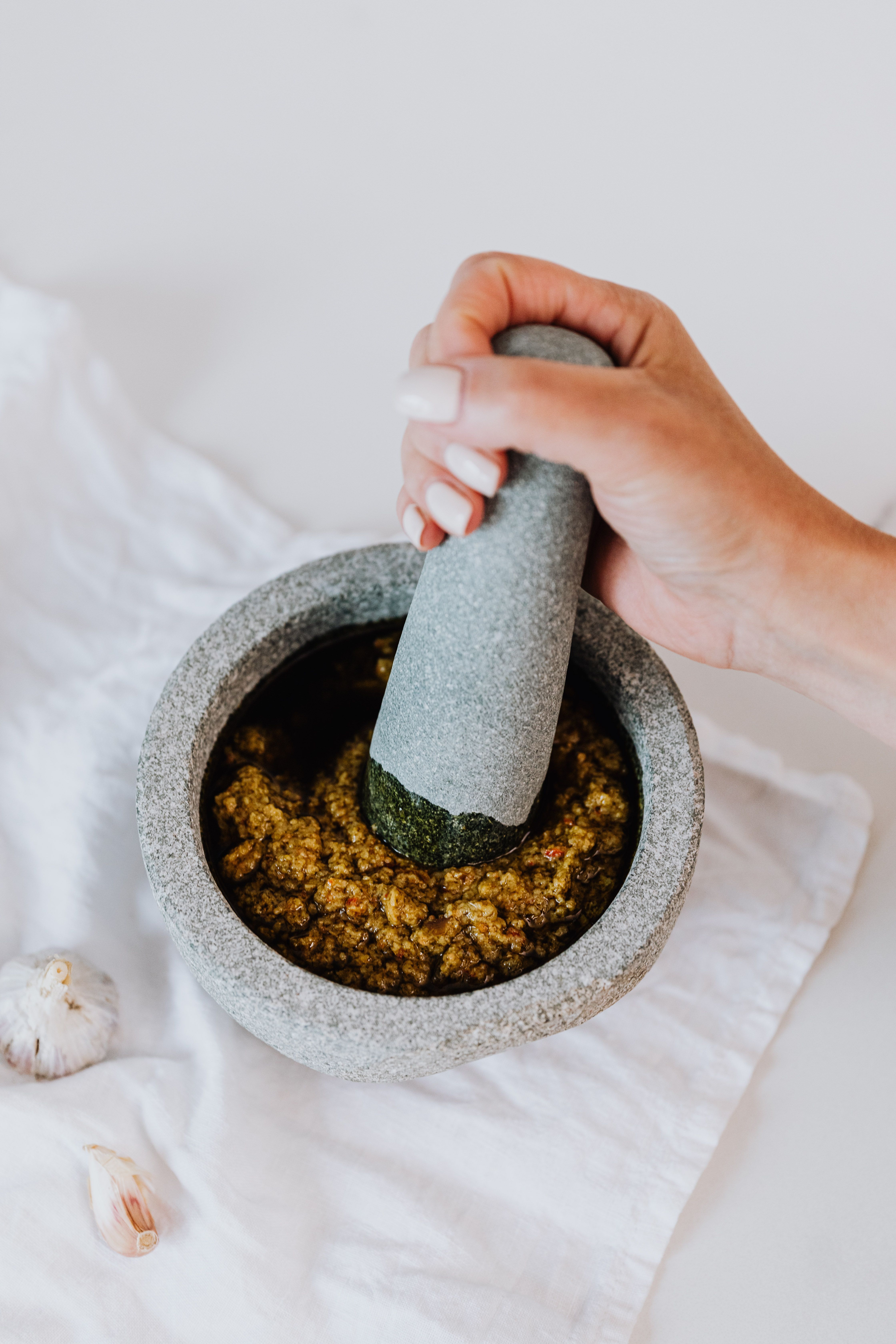 Person Holding Grinding Using Mortar and Pestle · Free Stock Photo