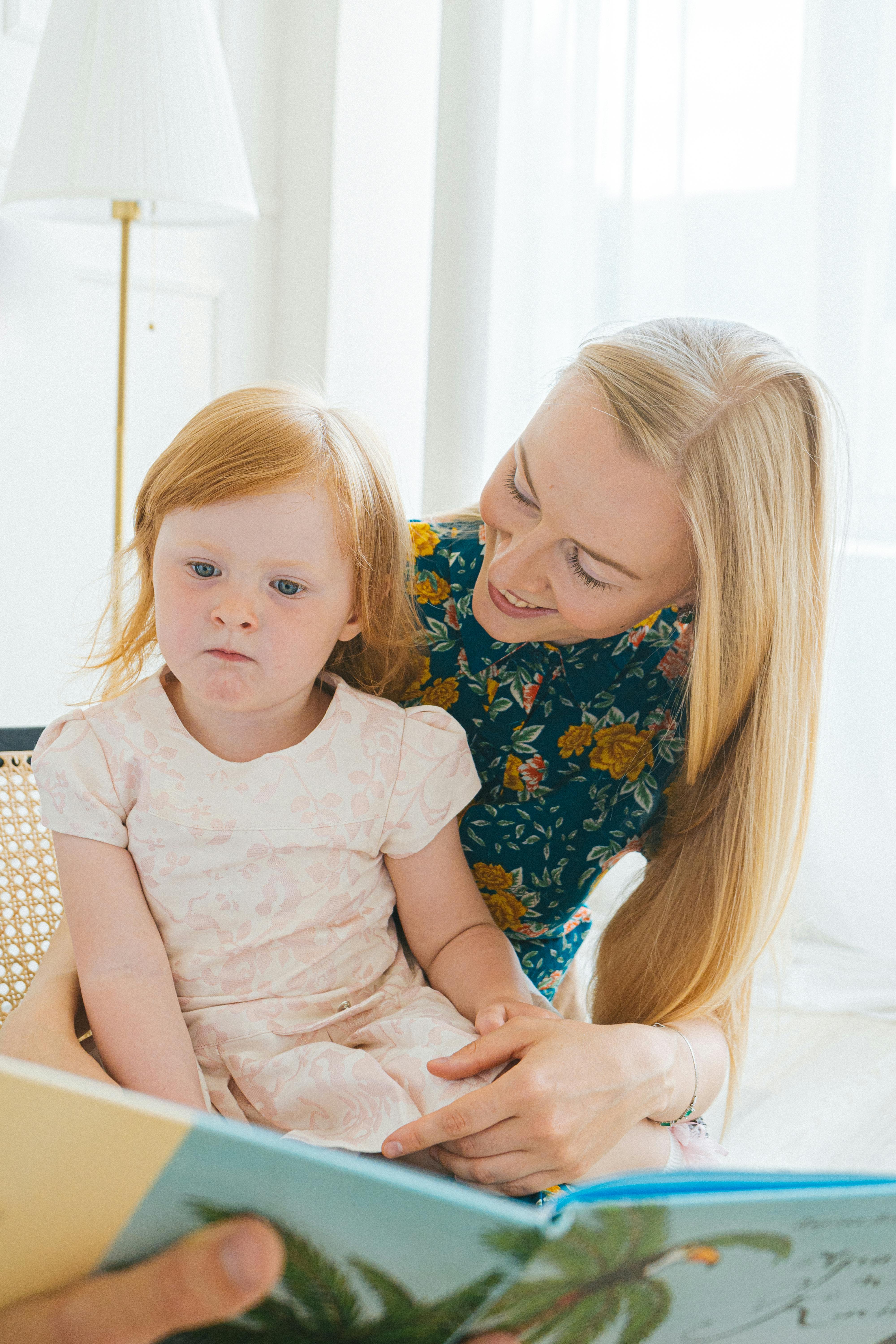 Girl Sitting on the Lap of a Woman · Free Stock Photo