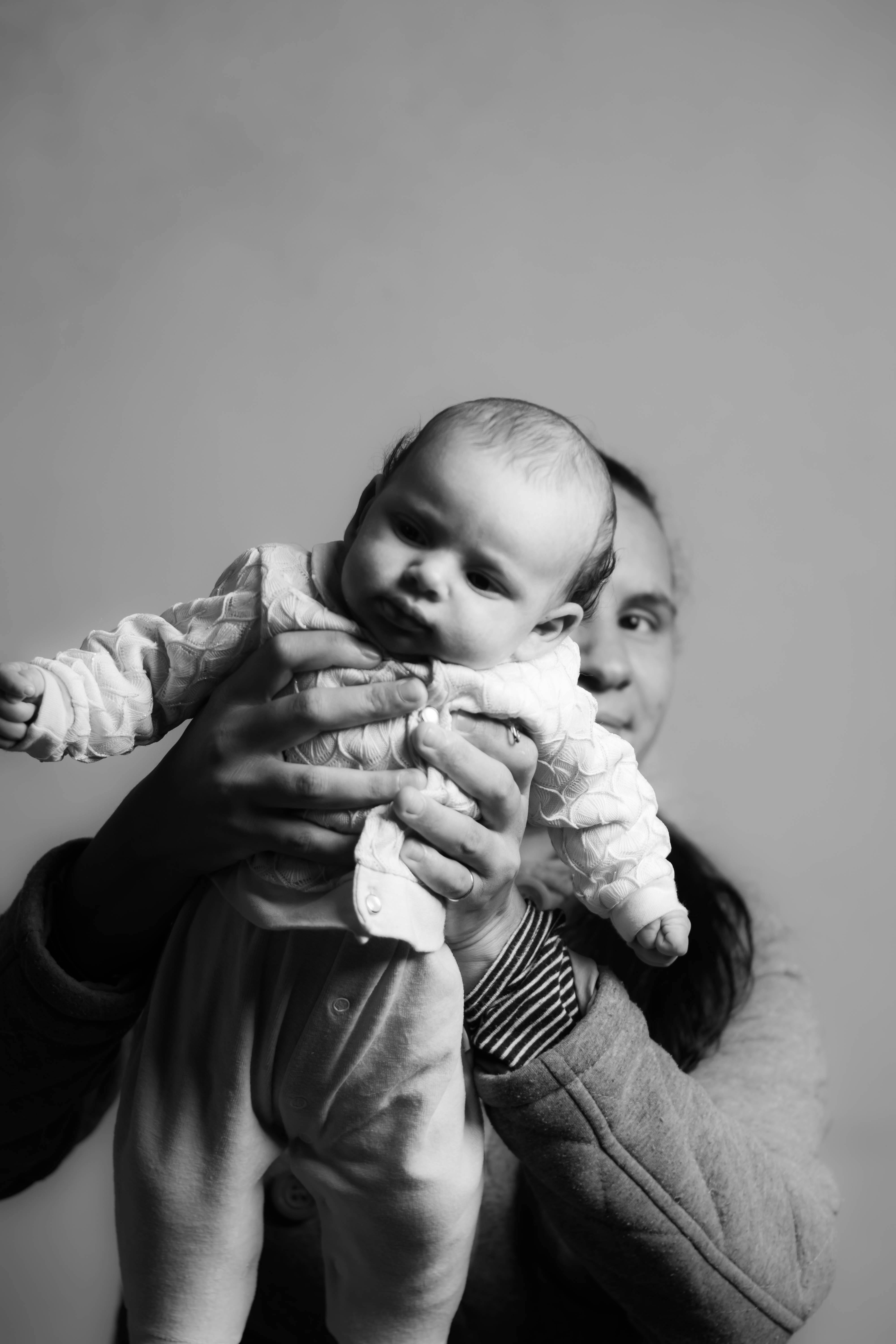 Grayscale Photo Of Man Carrying Baby · Free Stock Photo