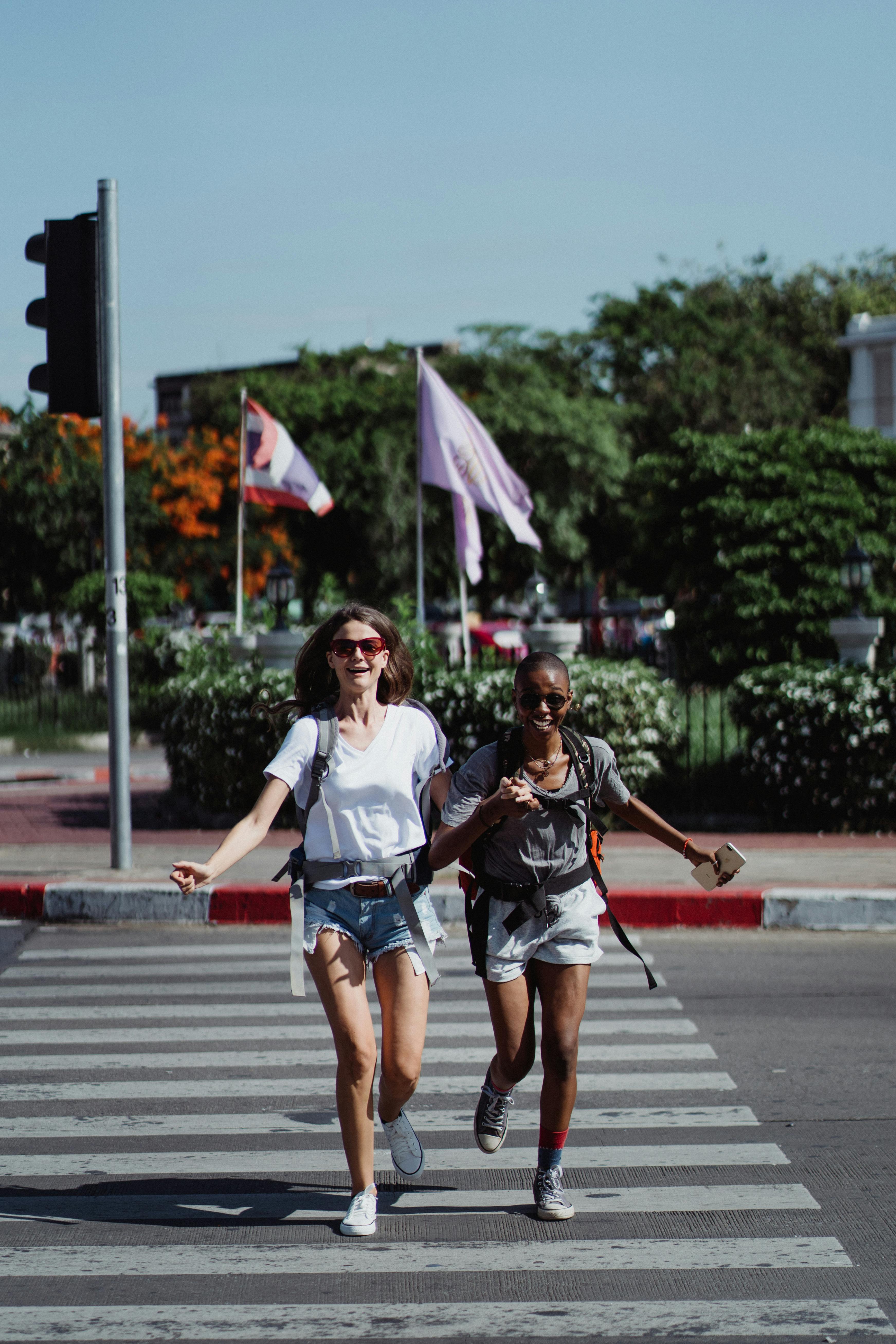 Photo of Women Running to Cross a Road · Free Stock Photo