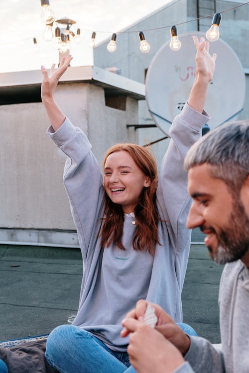Man In White Long Sleeve Shirt Beside Woman In Gray Long Sleeve Shirt