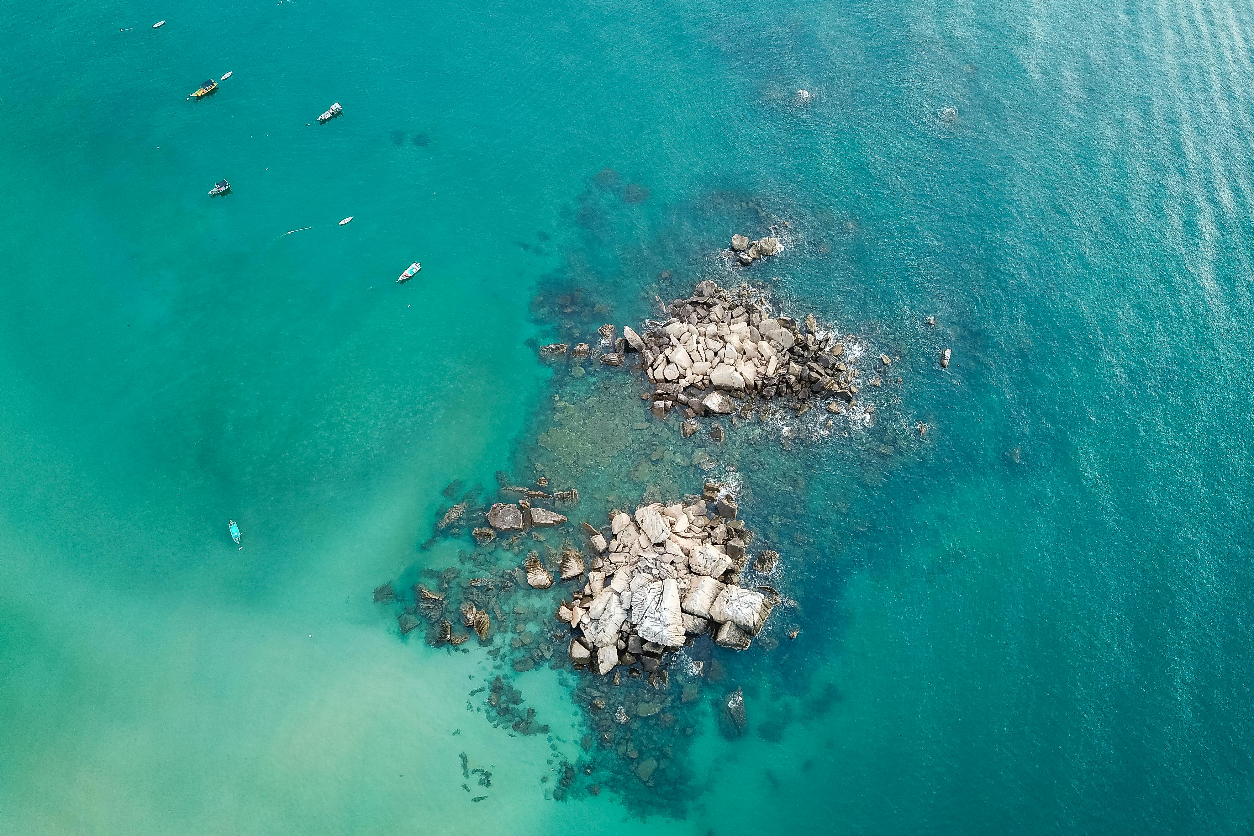 Modern boat floating in emerald water of clear sea · Free Stock Photo