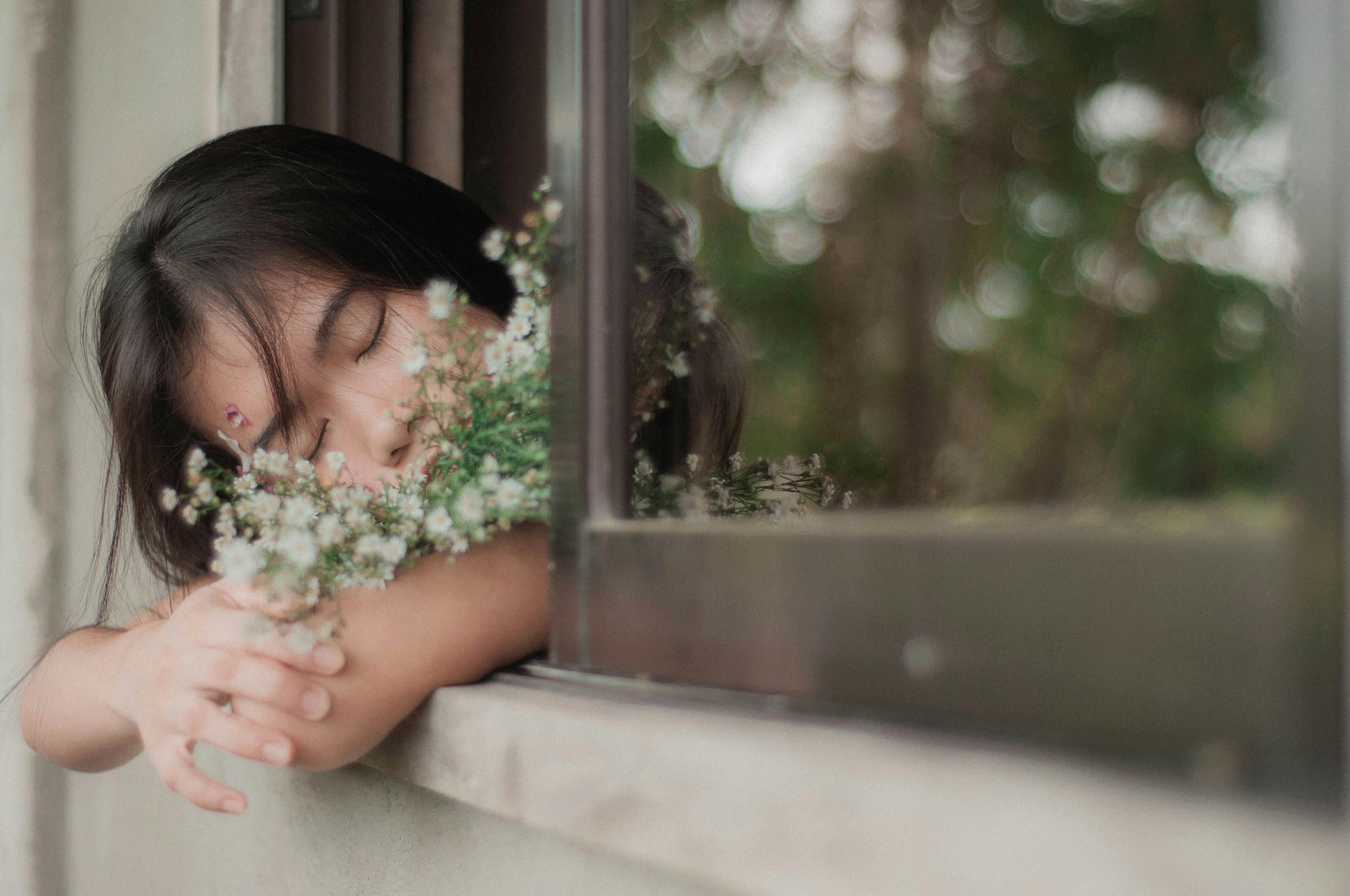 Girl with Flowers Sleeping in Window · Free Stock Photo