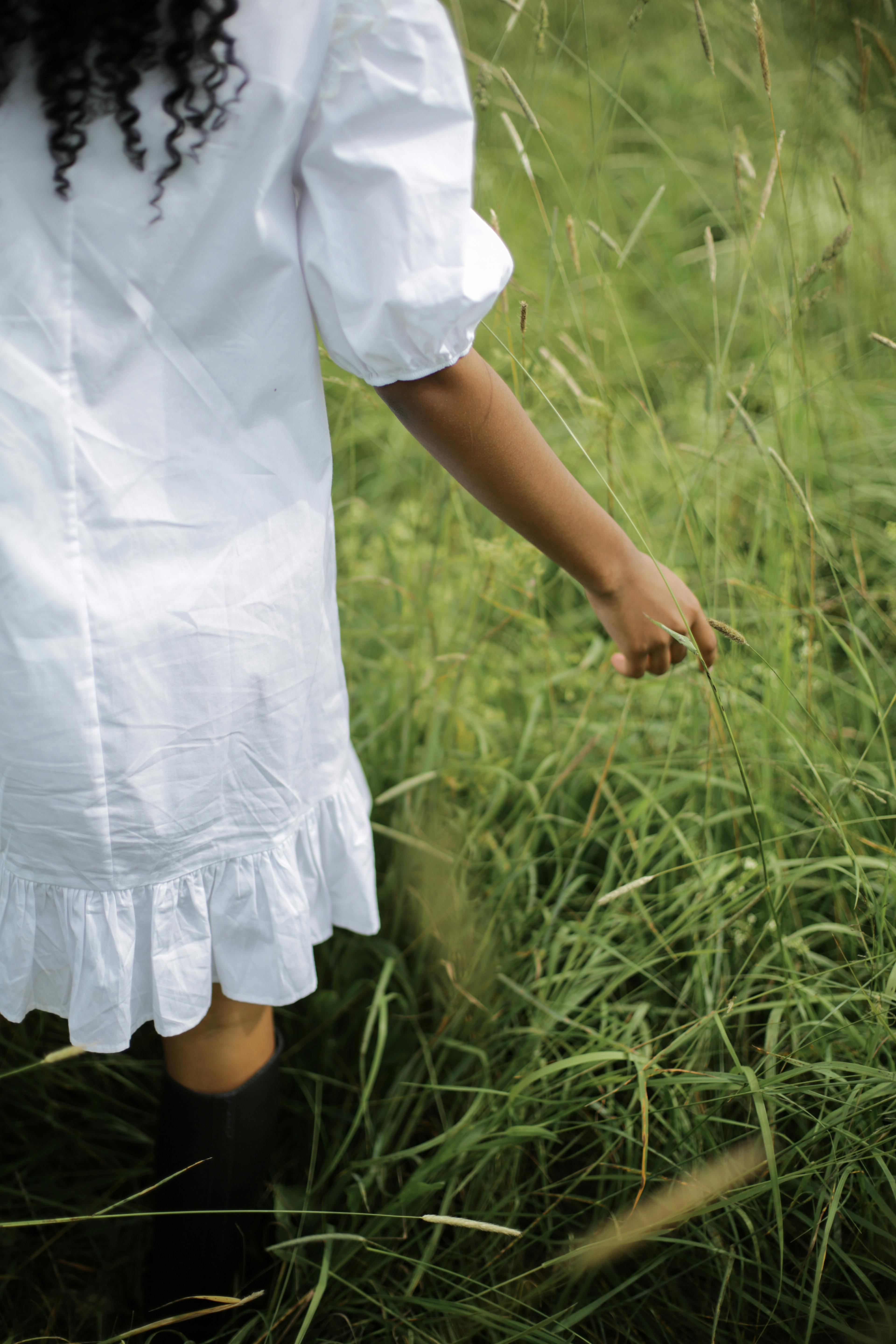 Girl in White Dress Standing on Green Grass Field · Free Stock Photo
