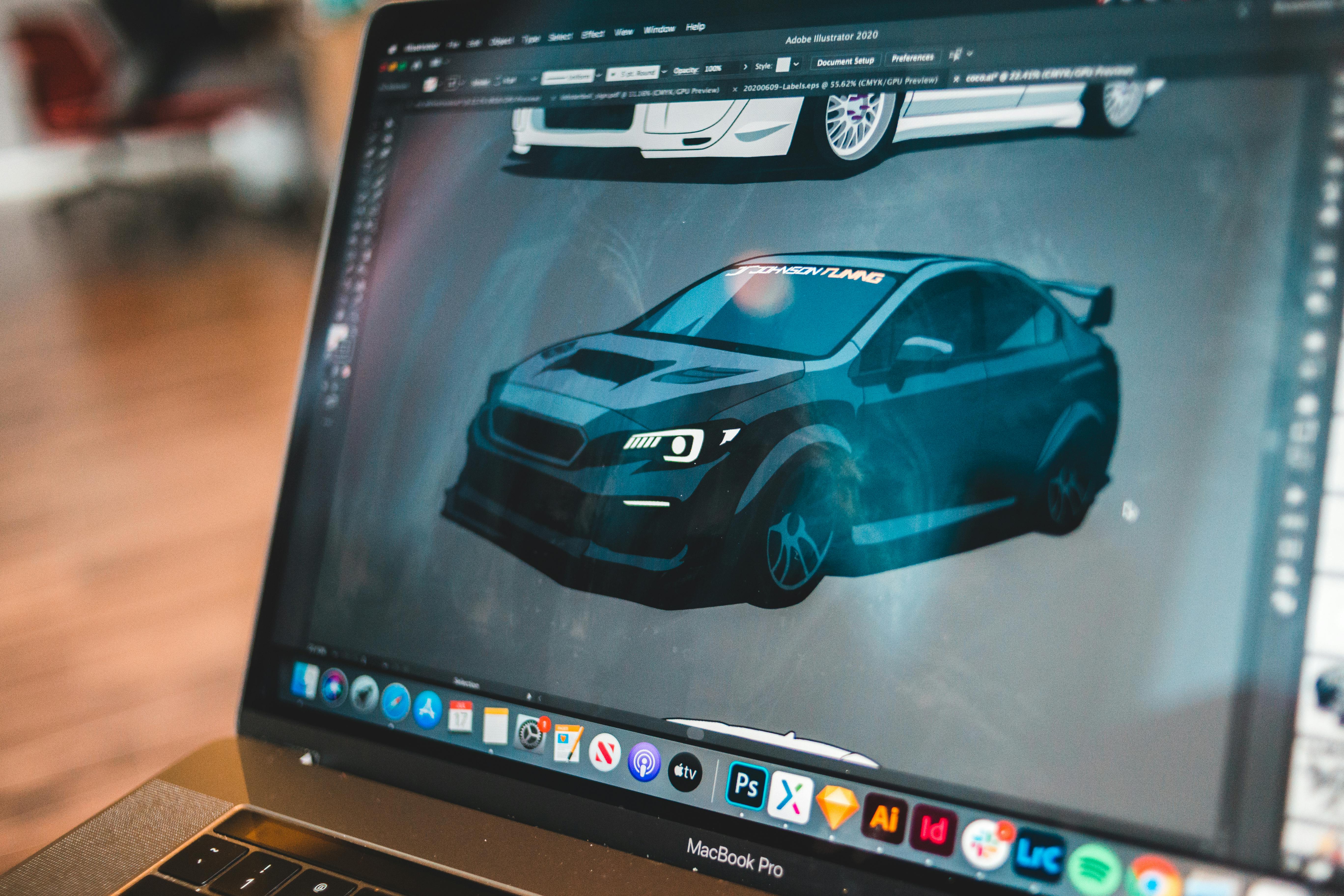 Modern laptop with sports car illustration on screen · Free Stock Photo