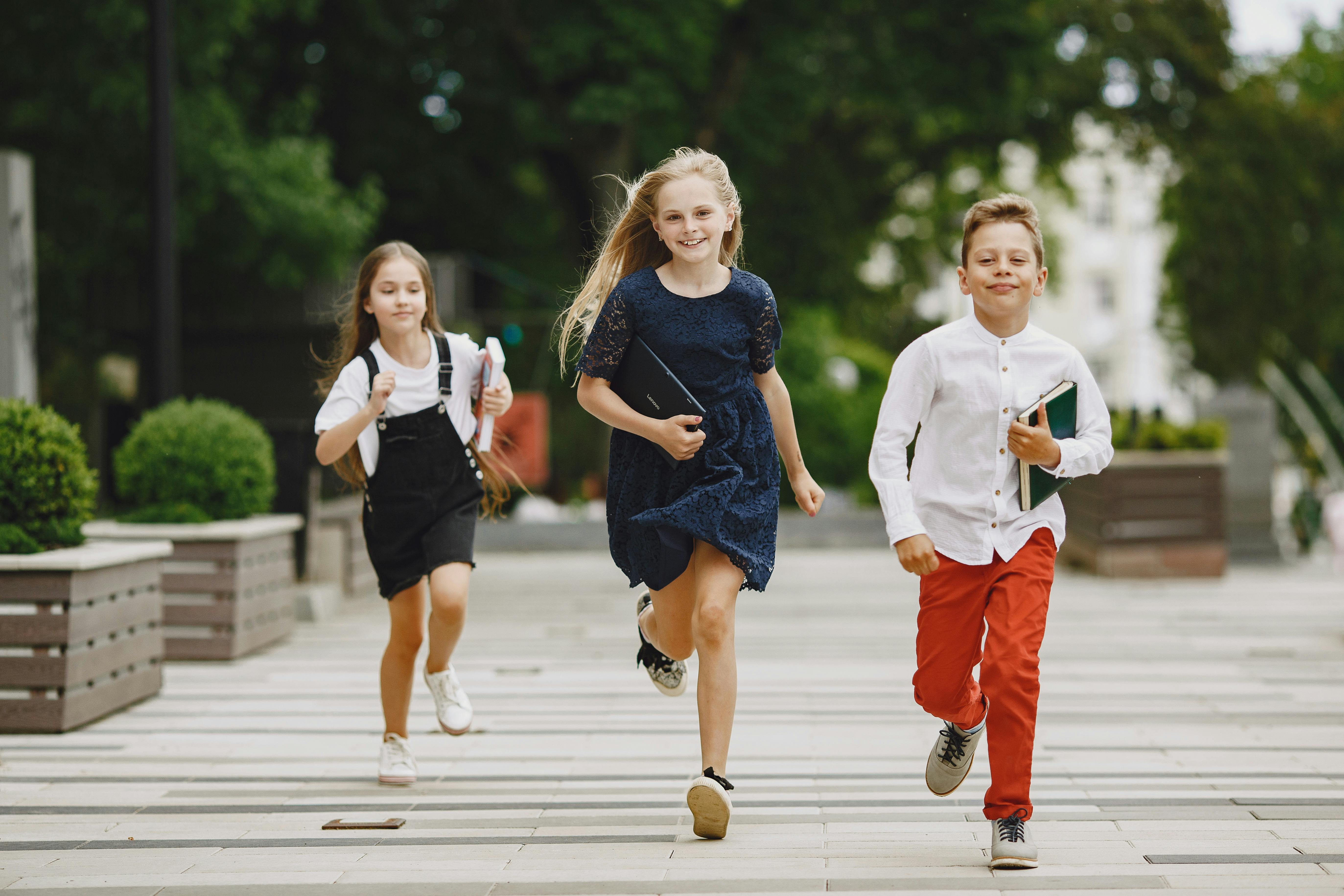 Kids Running Together on Sidewalk · Free Stock Photo